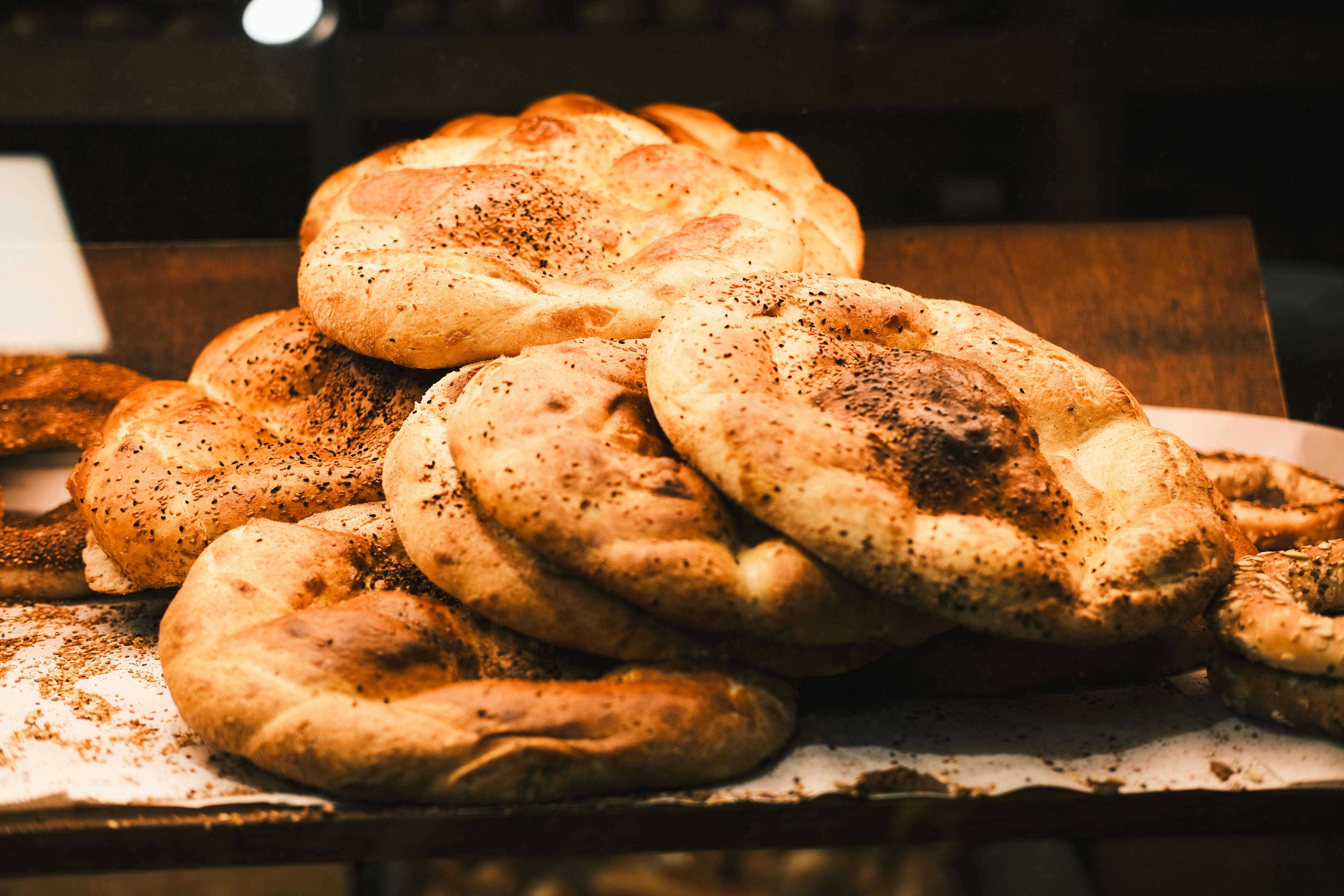 A stack of breads on a wooden table · Free Stock Photo