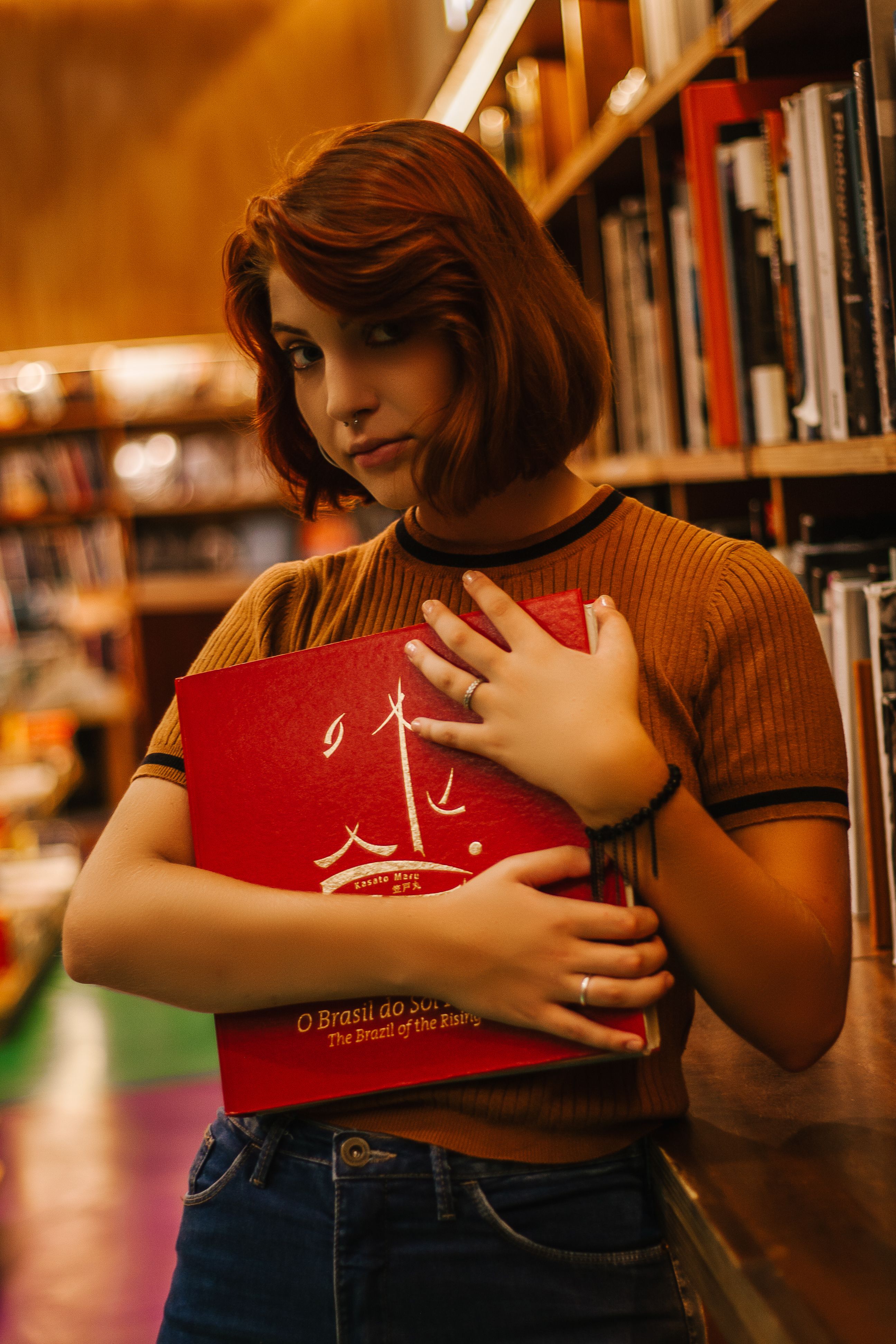 Woman Carrying Book Inside Library · Free Stock Photo