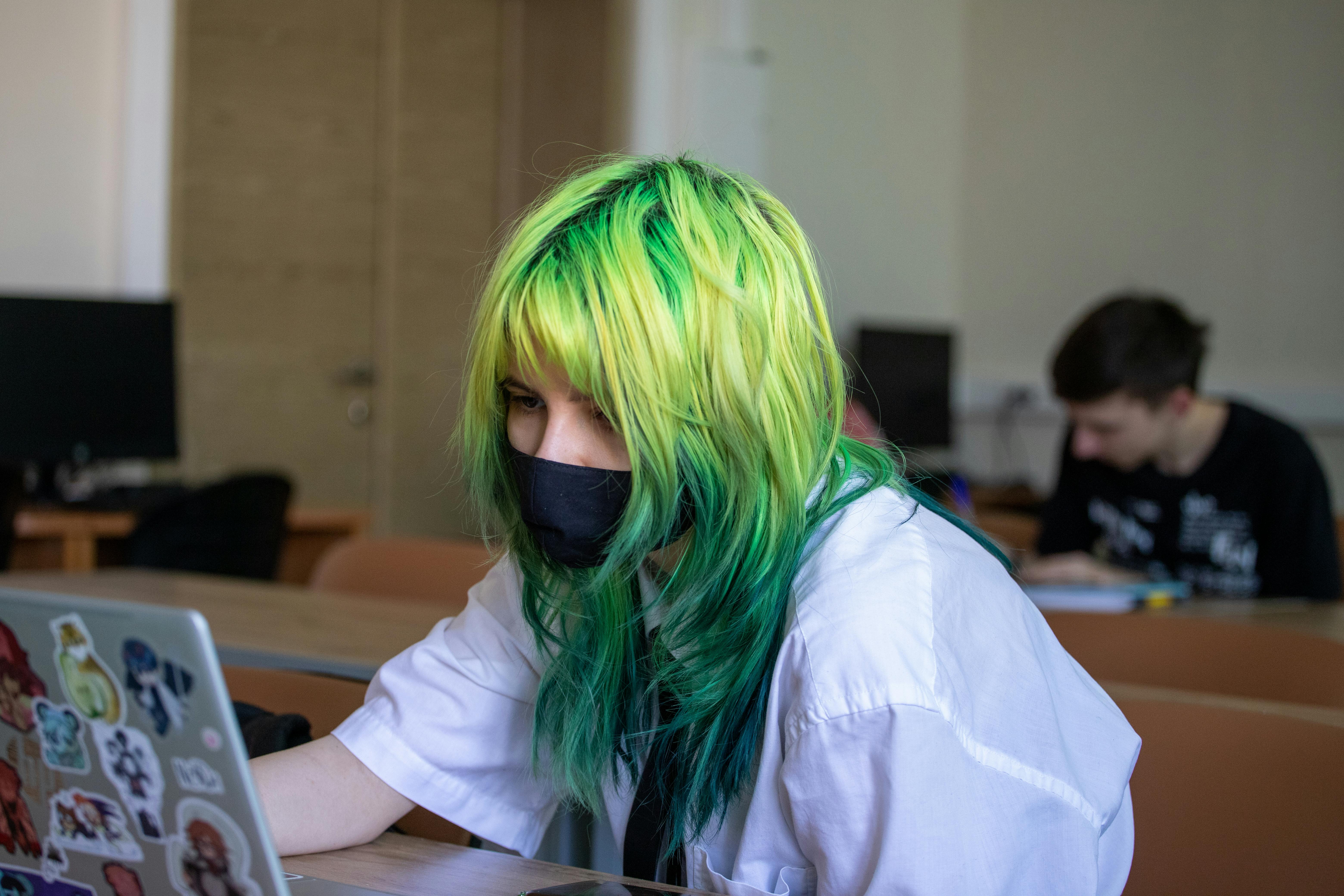 High School Student with Dyed, Green Hair Sitting by Desk · Free Stock ...