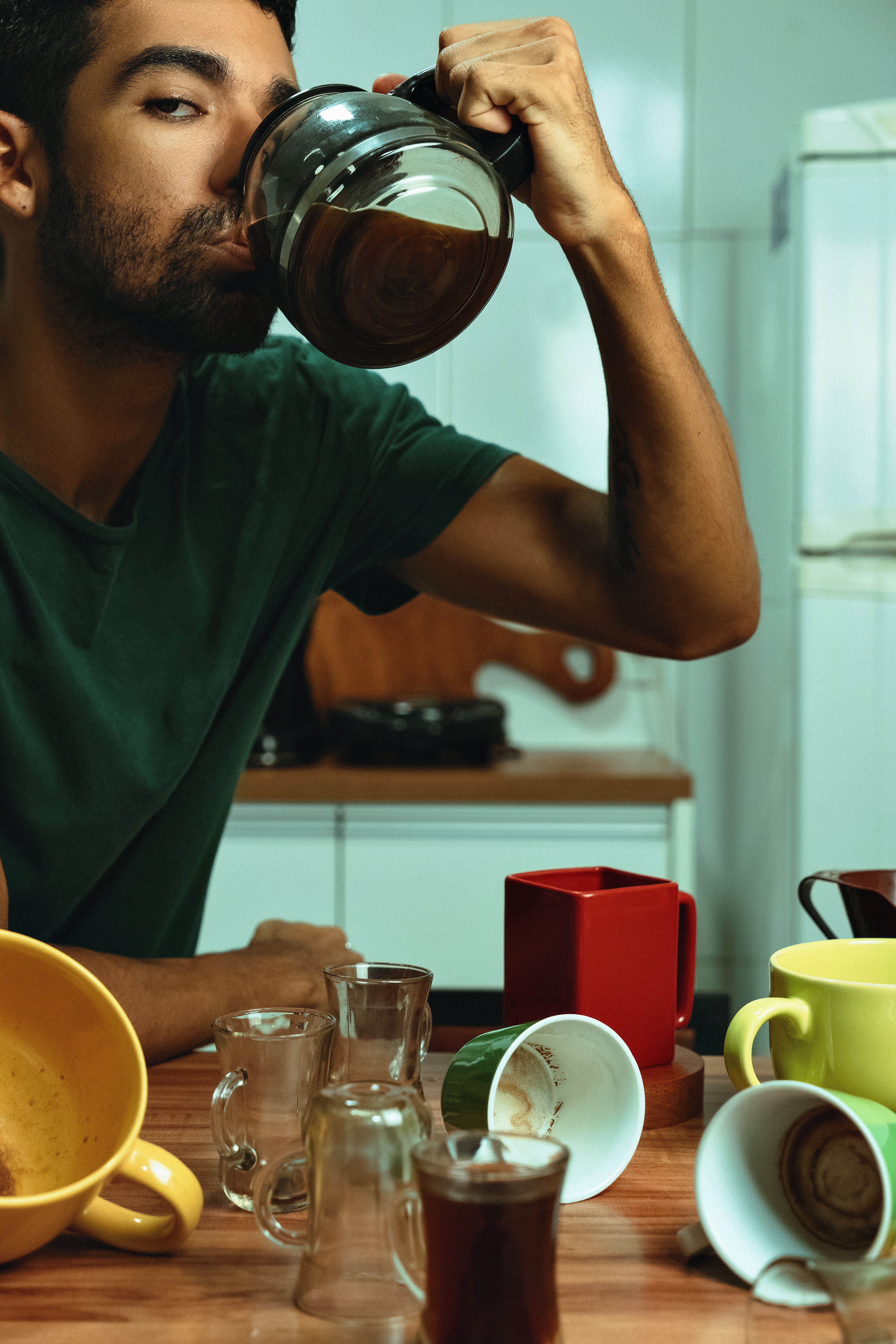 A man drinking coffee from a coffee pot · Free Stock Photo
