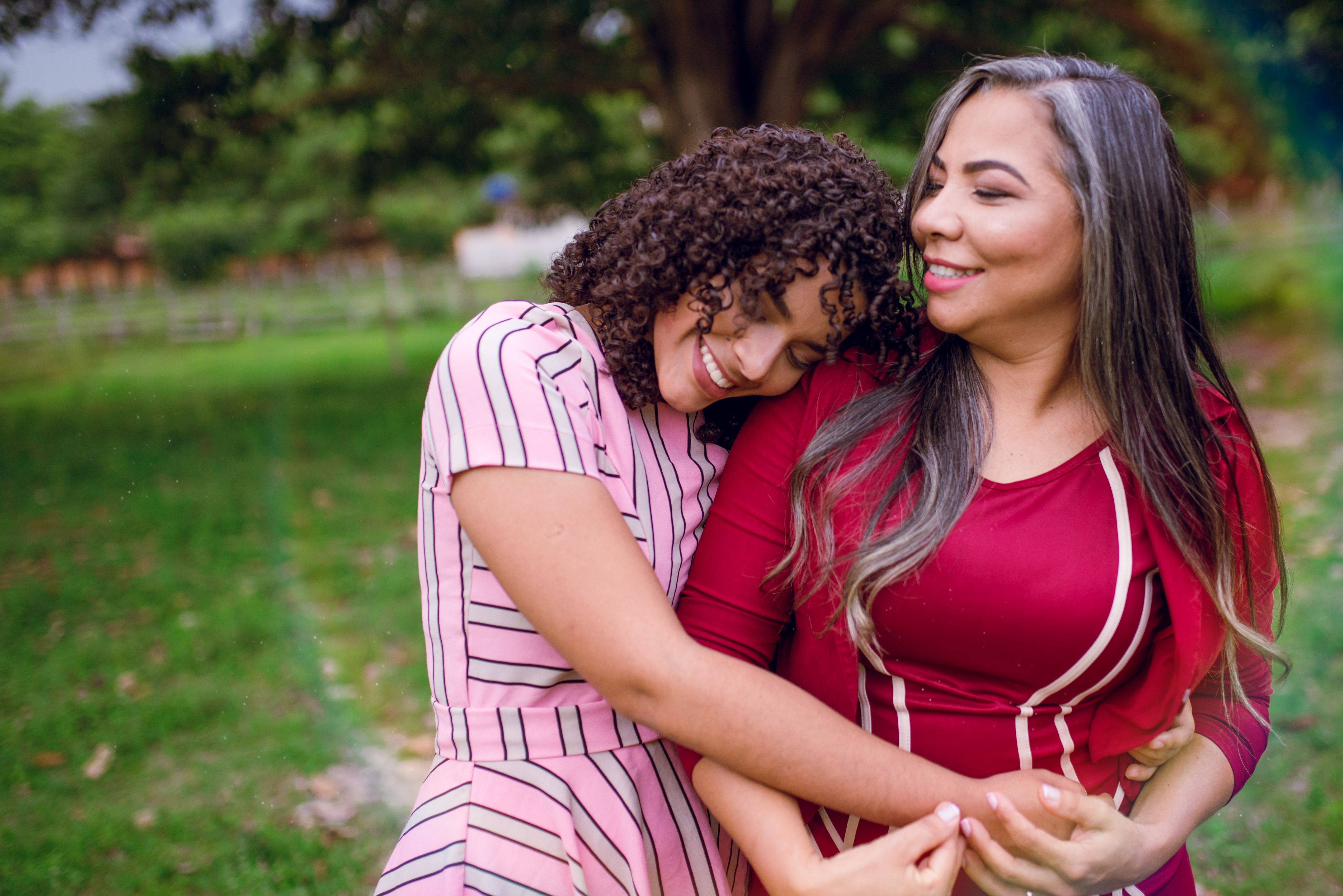 Woman Wearing Pink Dress Hugging Another Woman · Free Stock Photo
