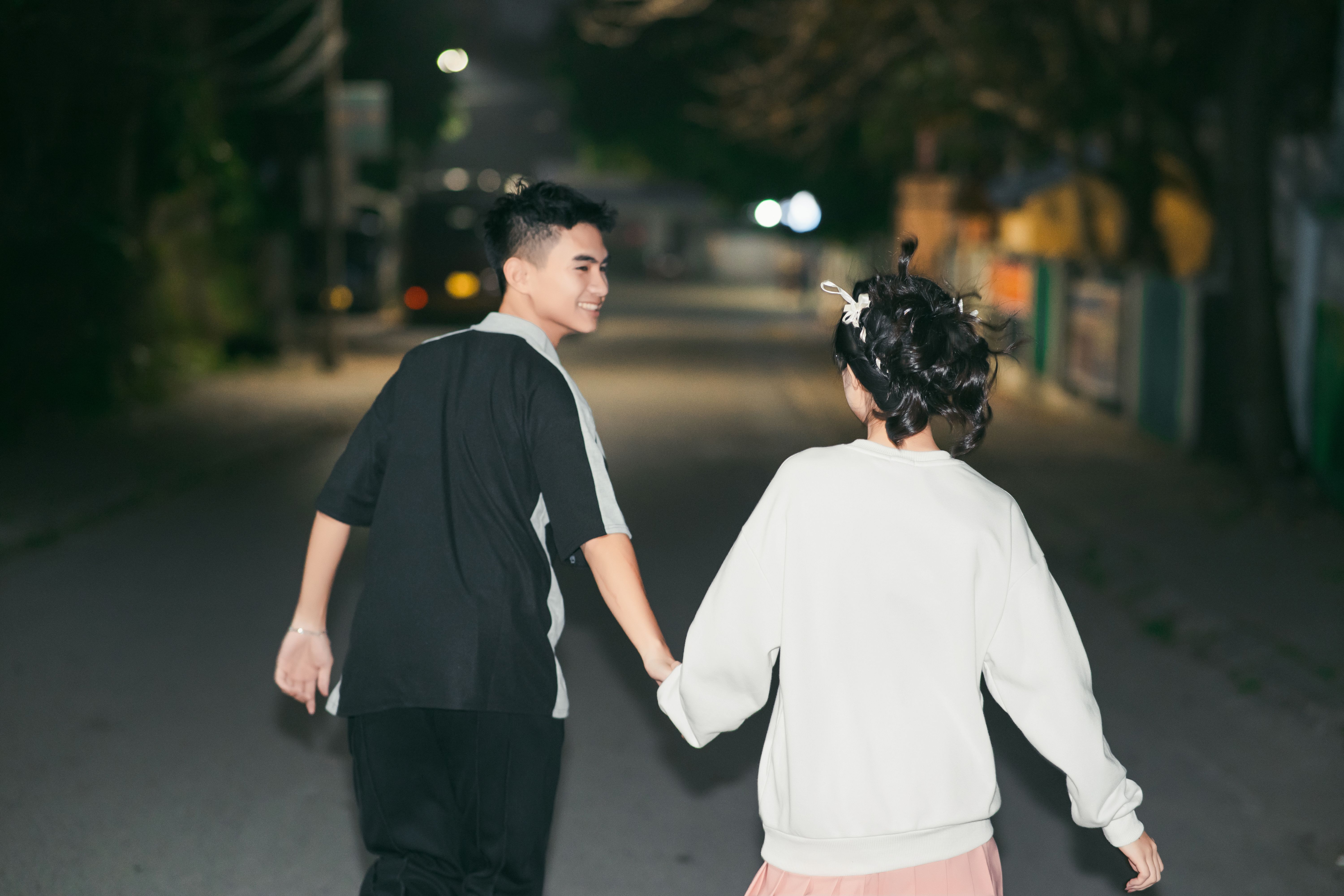 Couple Walking on a Street at Night · Free Stock Photo