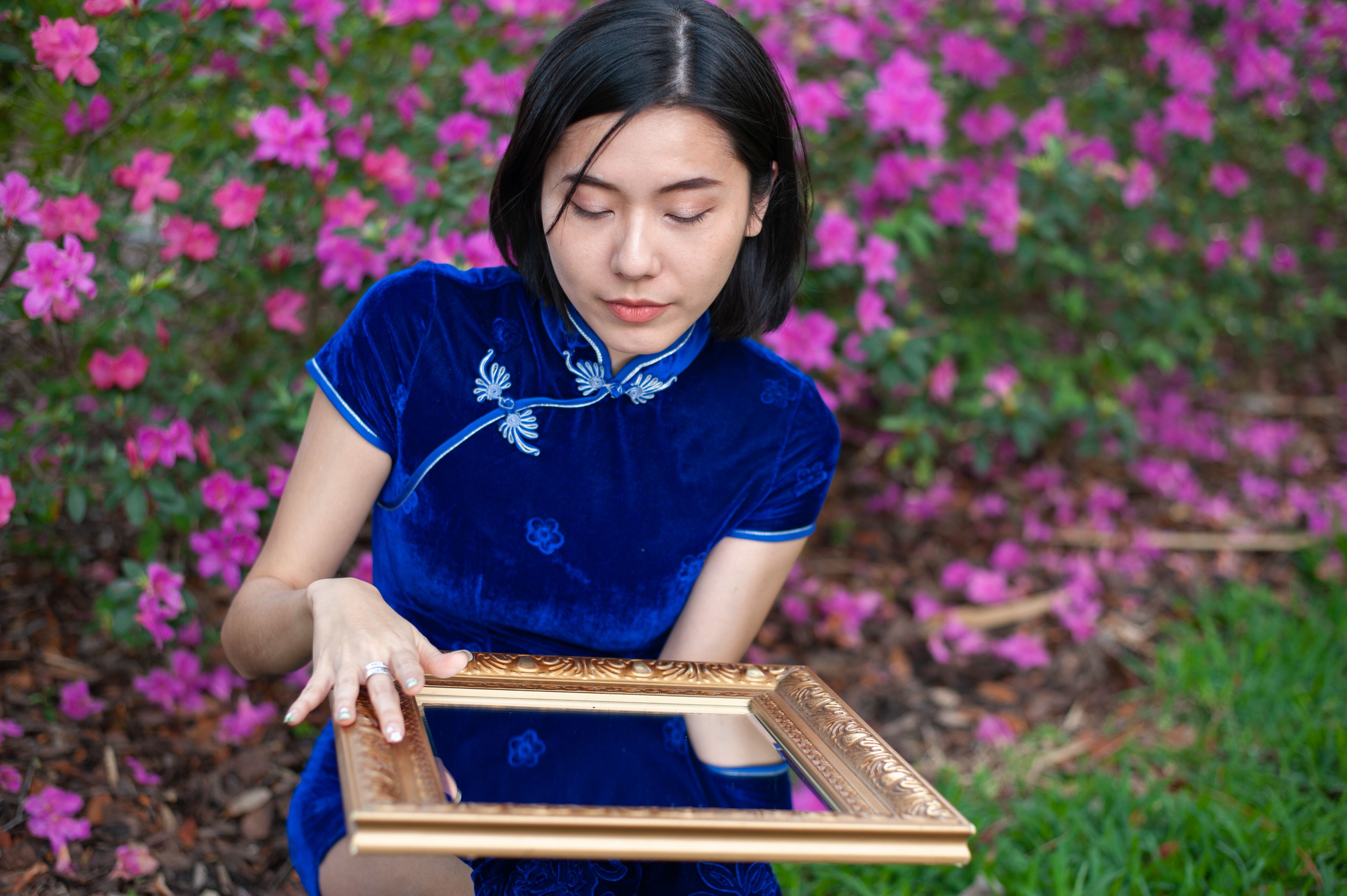 Model in Blue Velvet Cheongsam Dress Holding a Mirror · Free Stock Photo