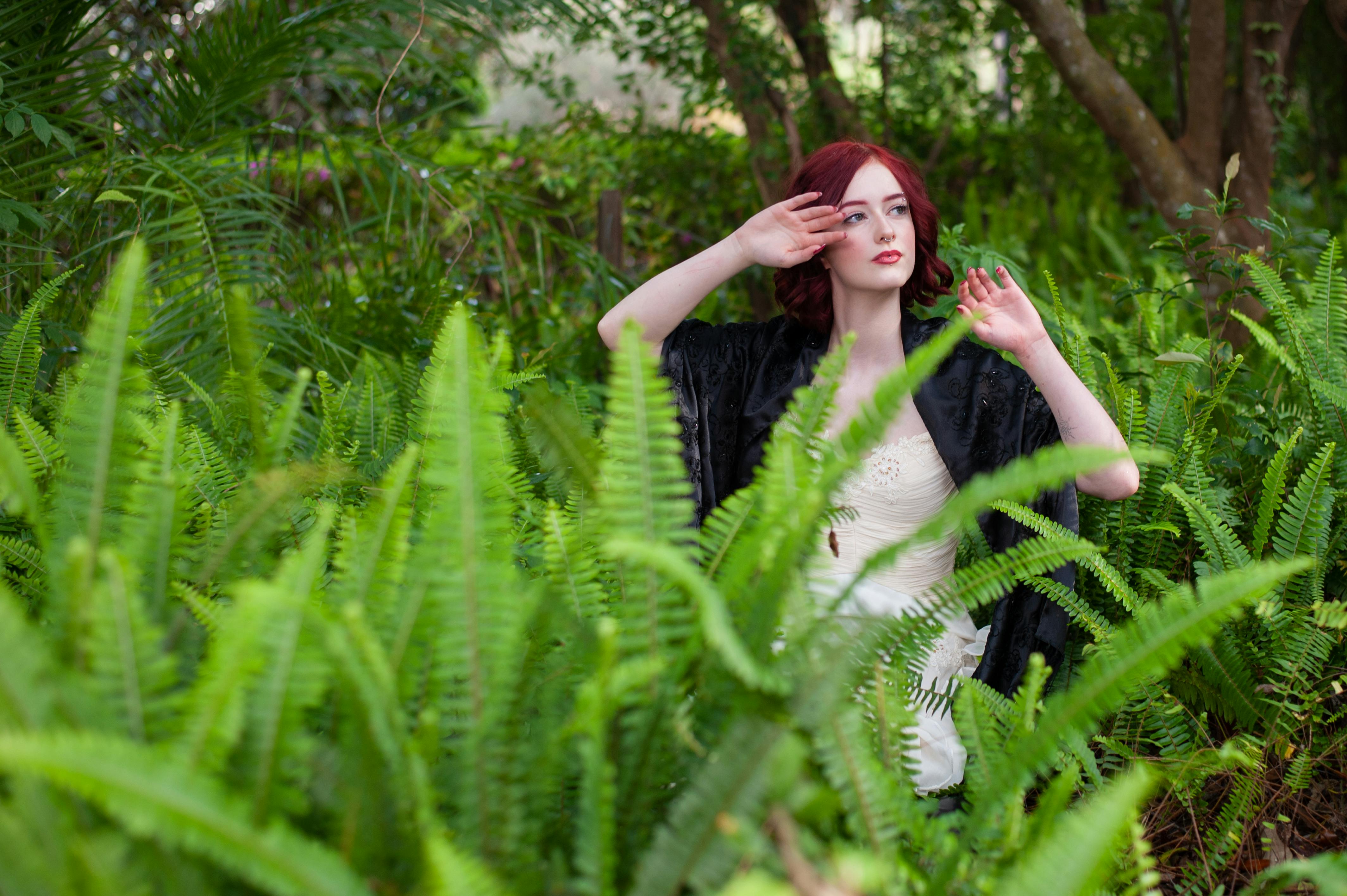 Model in a White Dress and Black Scarf Posing Among Ferns · Free Stock ...