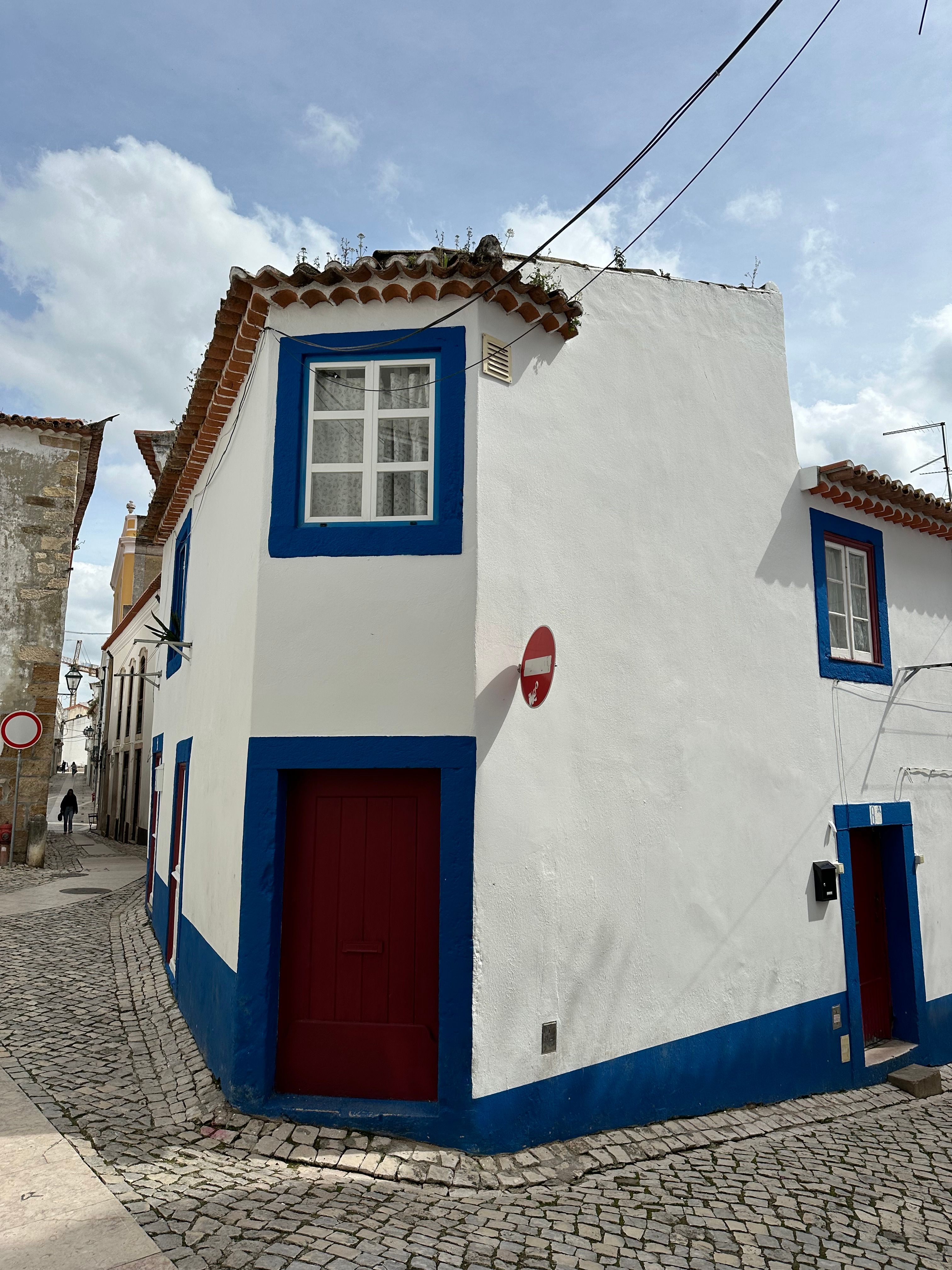 White and Blue Building by the Street in a Town · Free Stock Photo