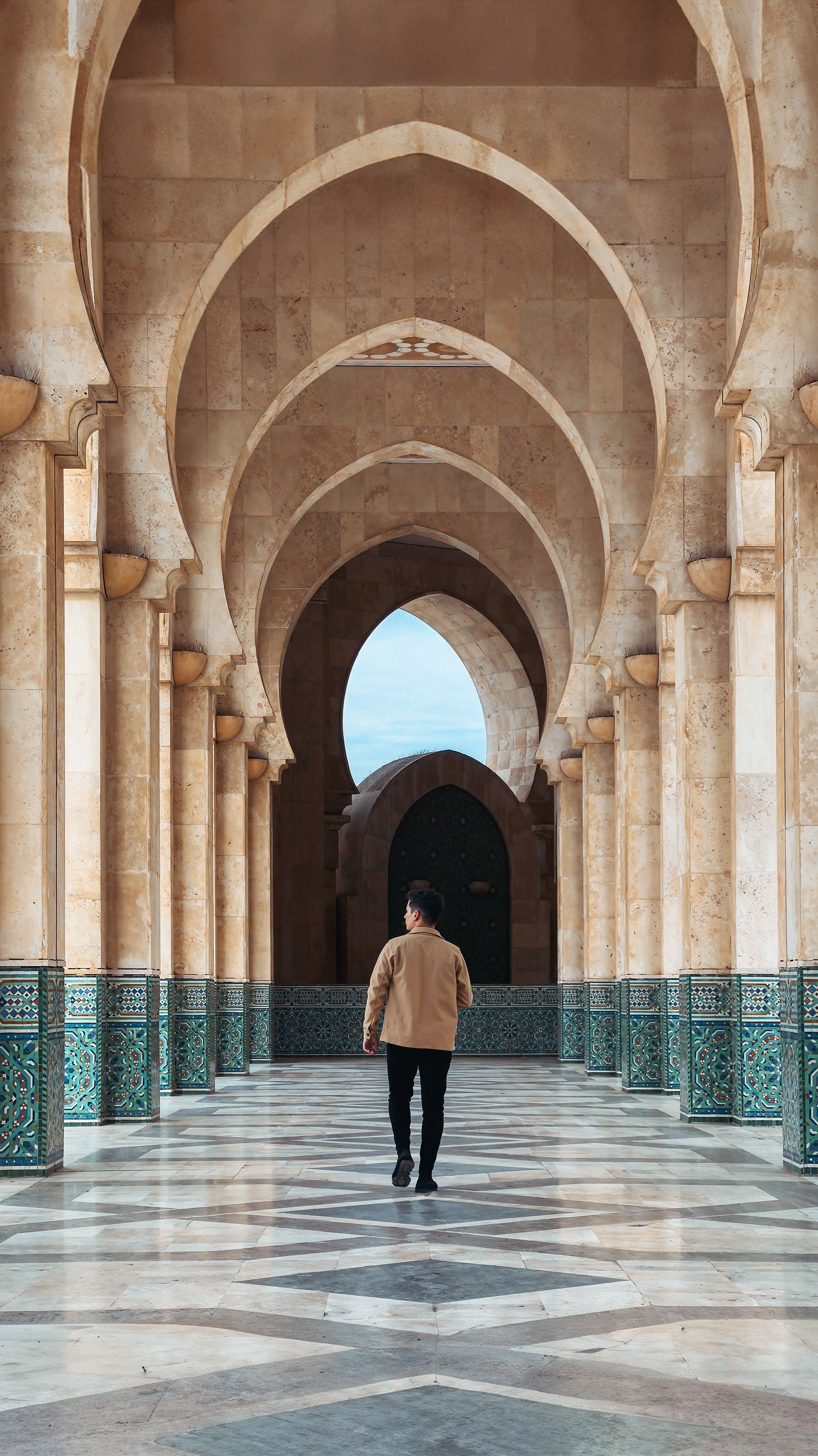 Man Walking in a Hall of a Mosque · Free Stock Photo