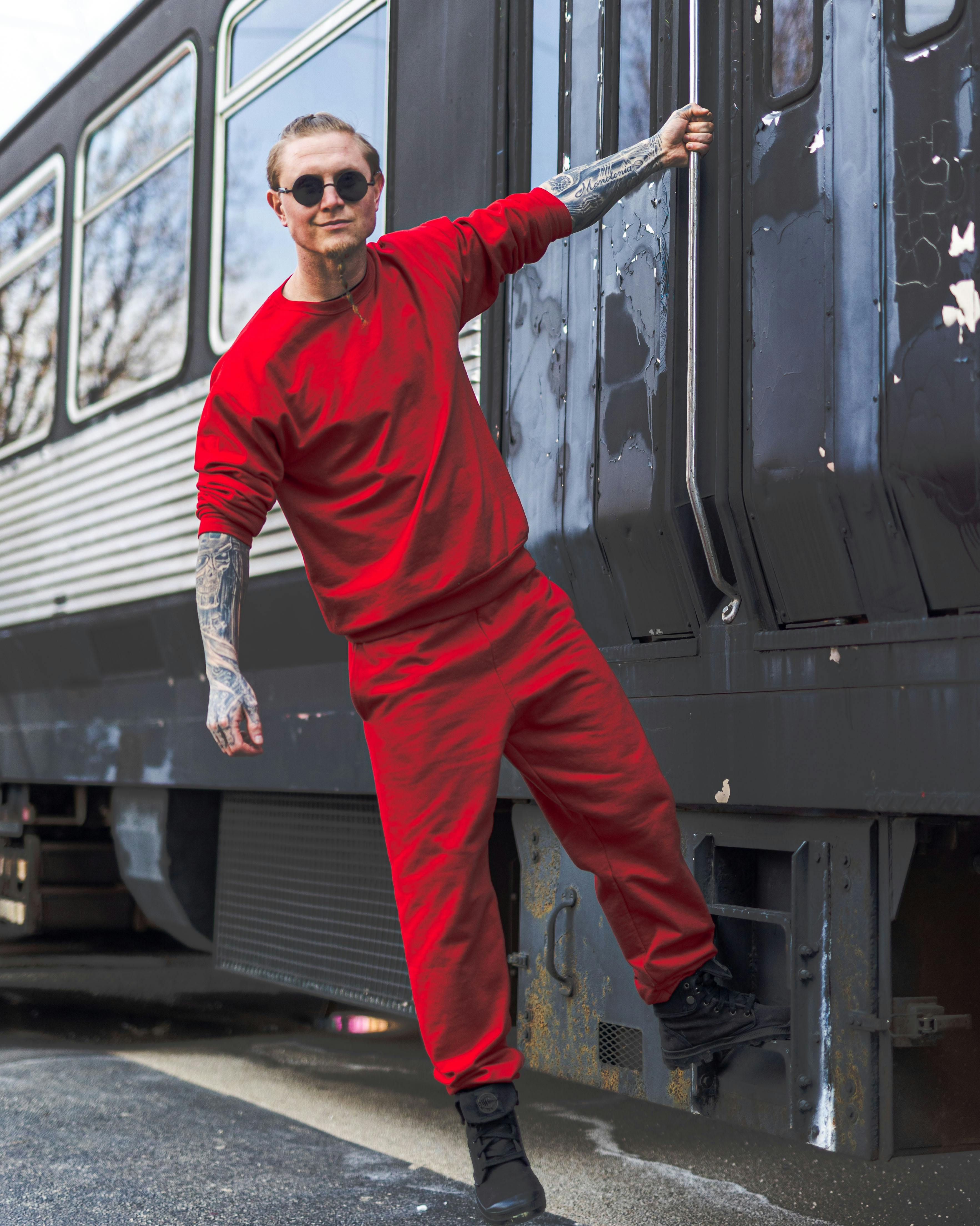 Man Wearing Red Clothes Posing by the Train · Free Stock Photo