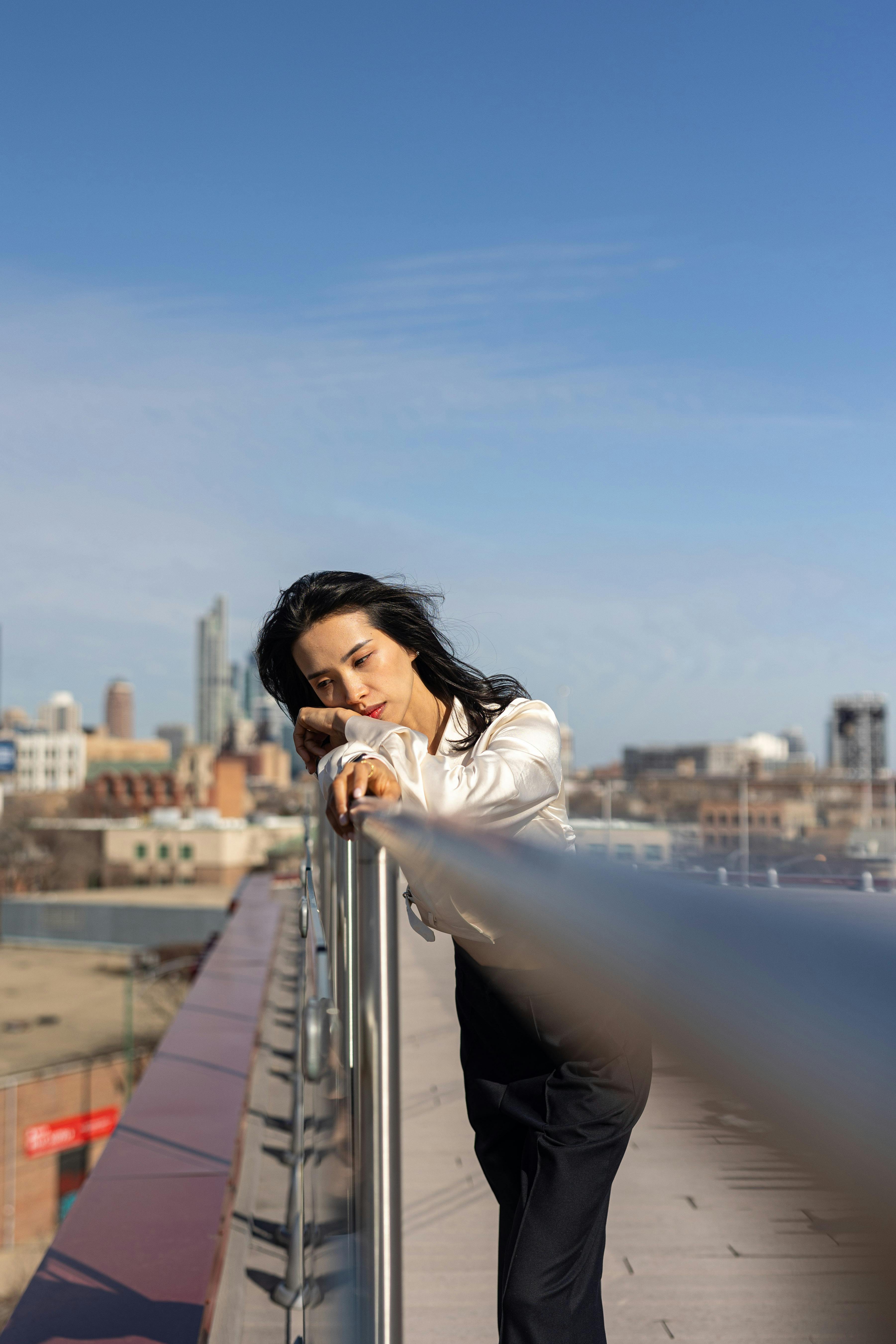 Woman Standing and Leaning on Railing · Free Stock Photo