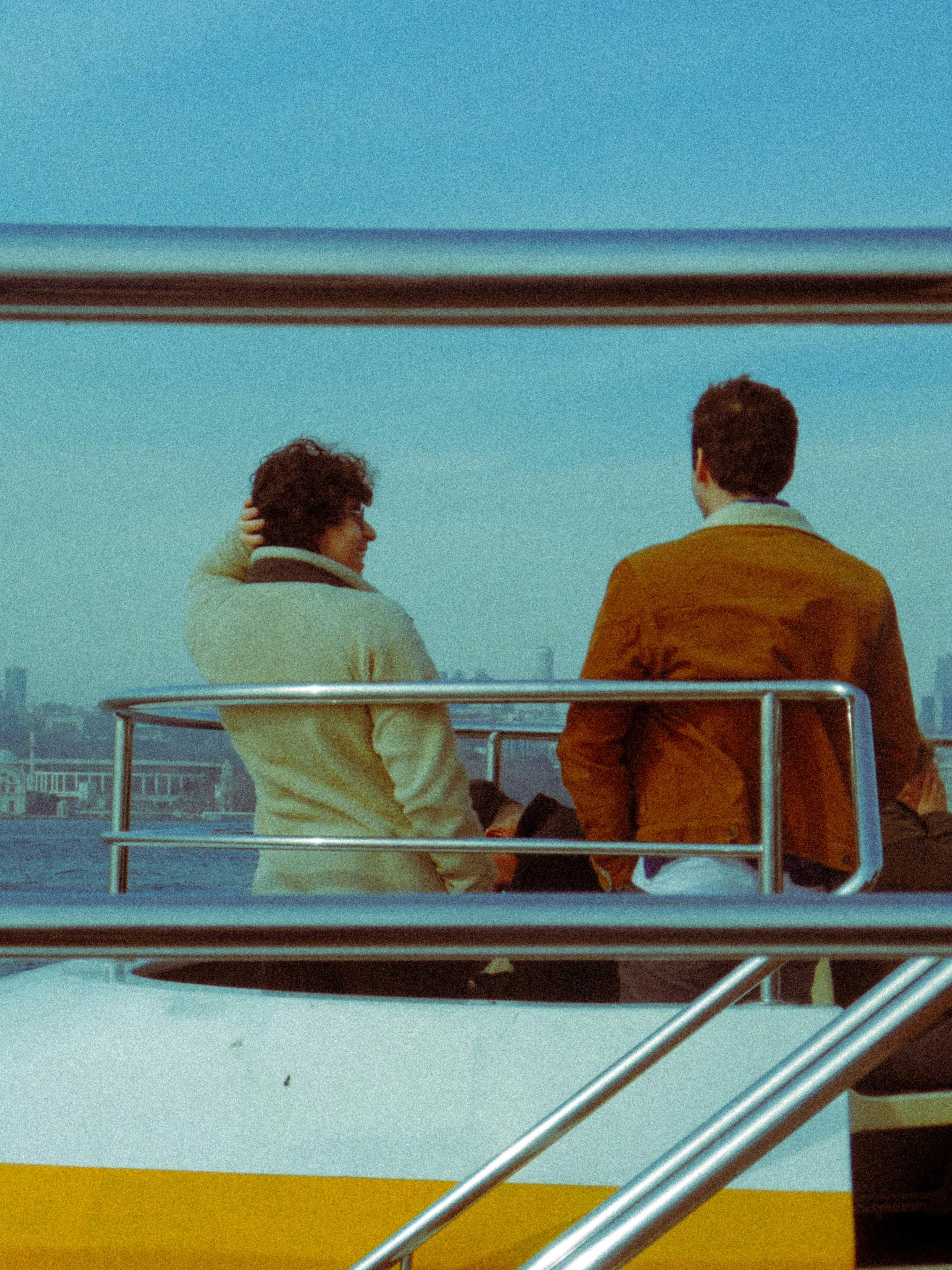 Back View of Men on a Ship · Free Stock Photo