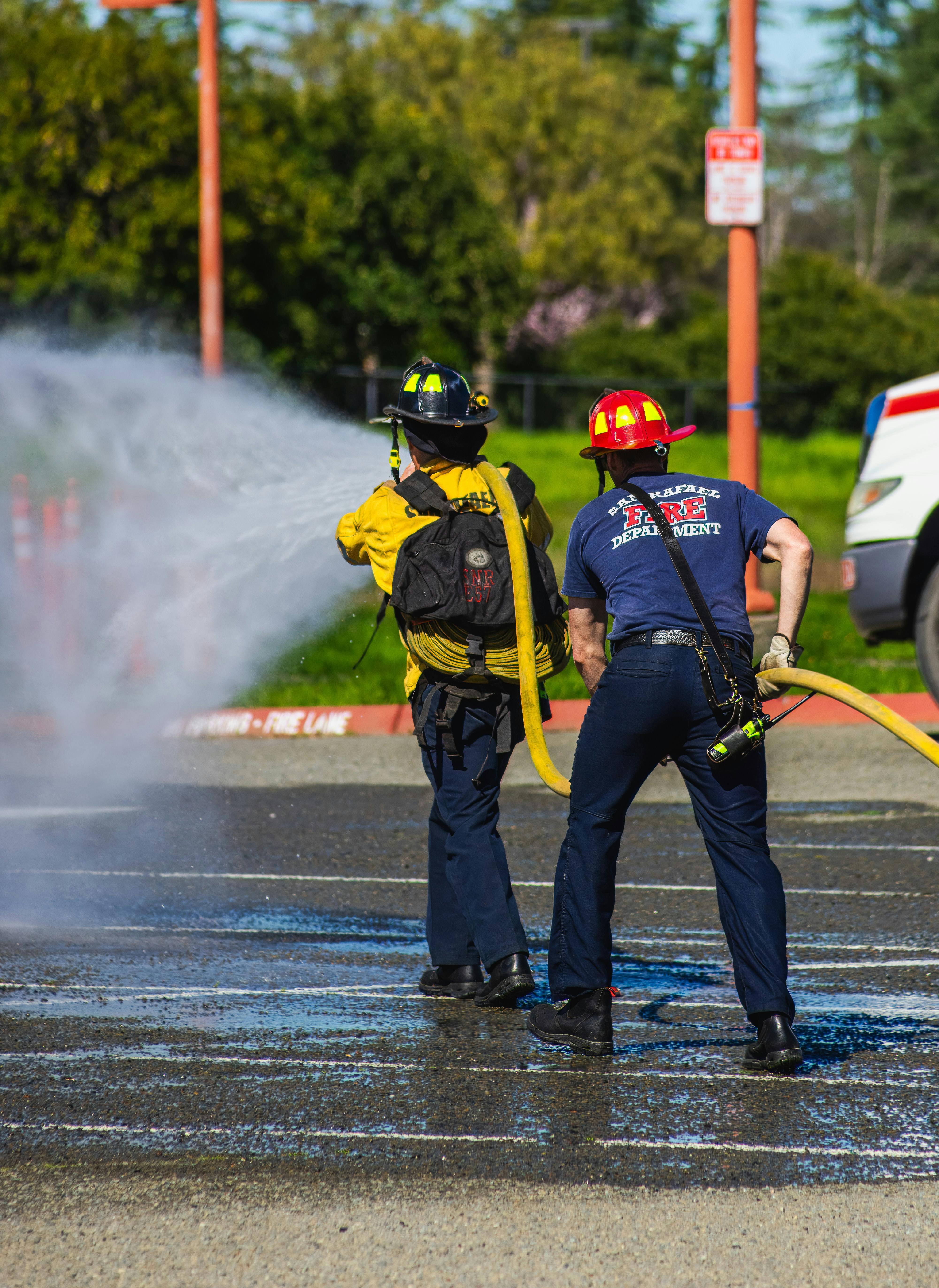 Back View of Firefighters on Street · Free Stock Photo