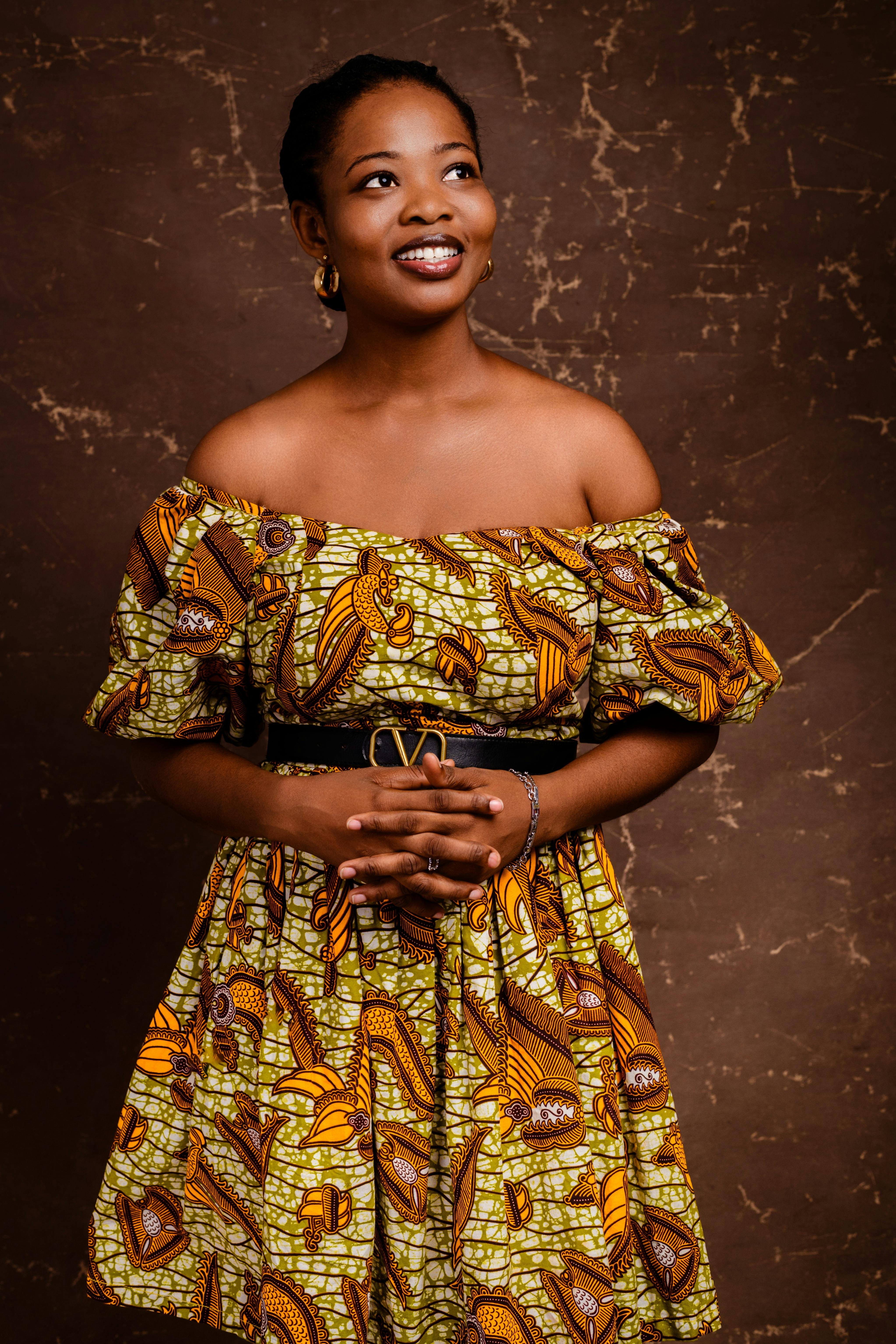 Smiling Model in Patterned Dress · Free Stock Photo