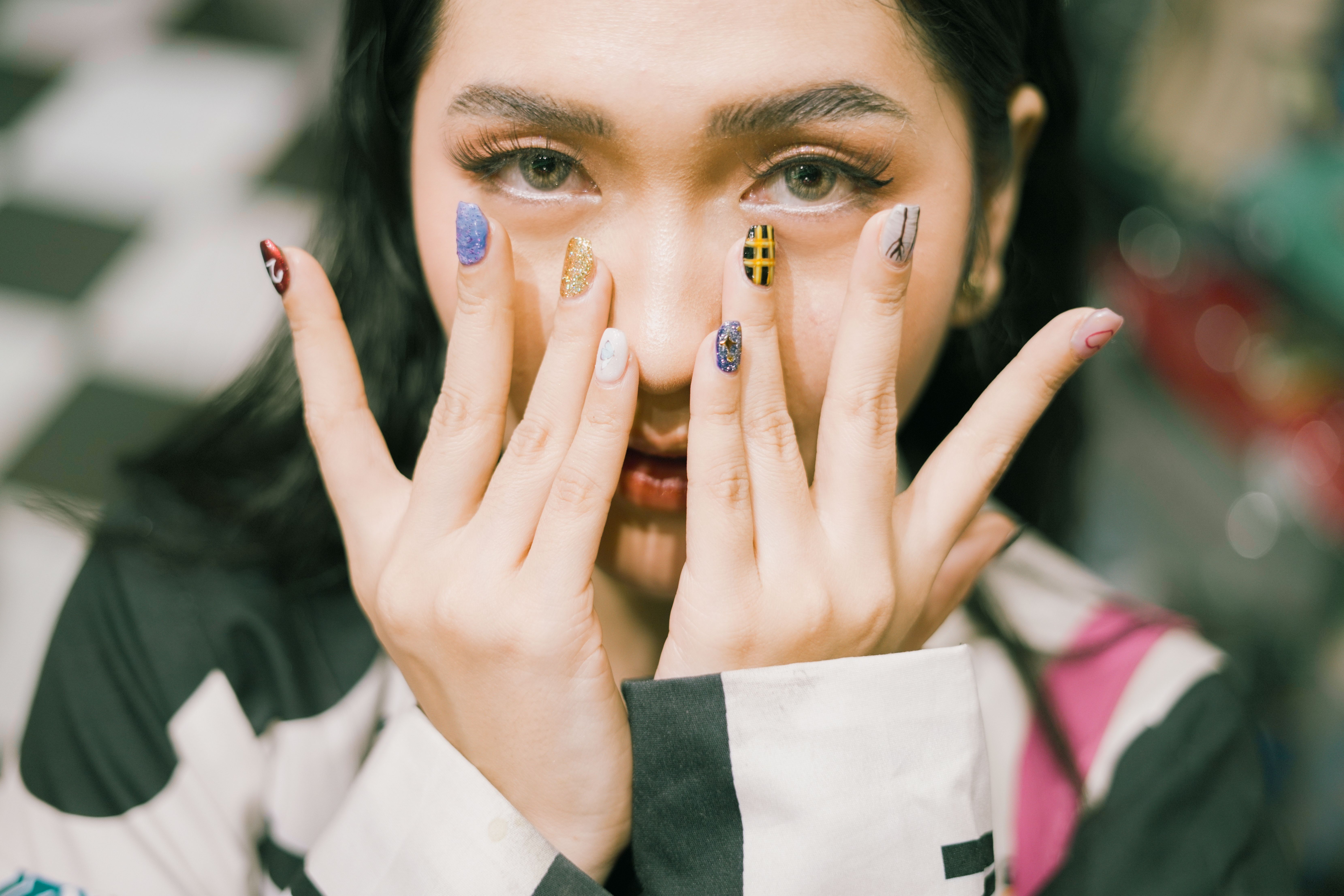 Young Woman with Various Acrylic Nails Touching Her Face · Free Stock Photo