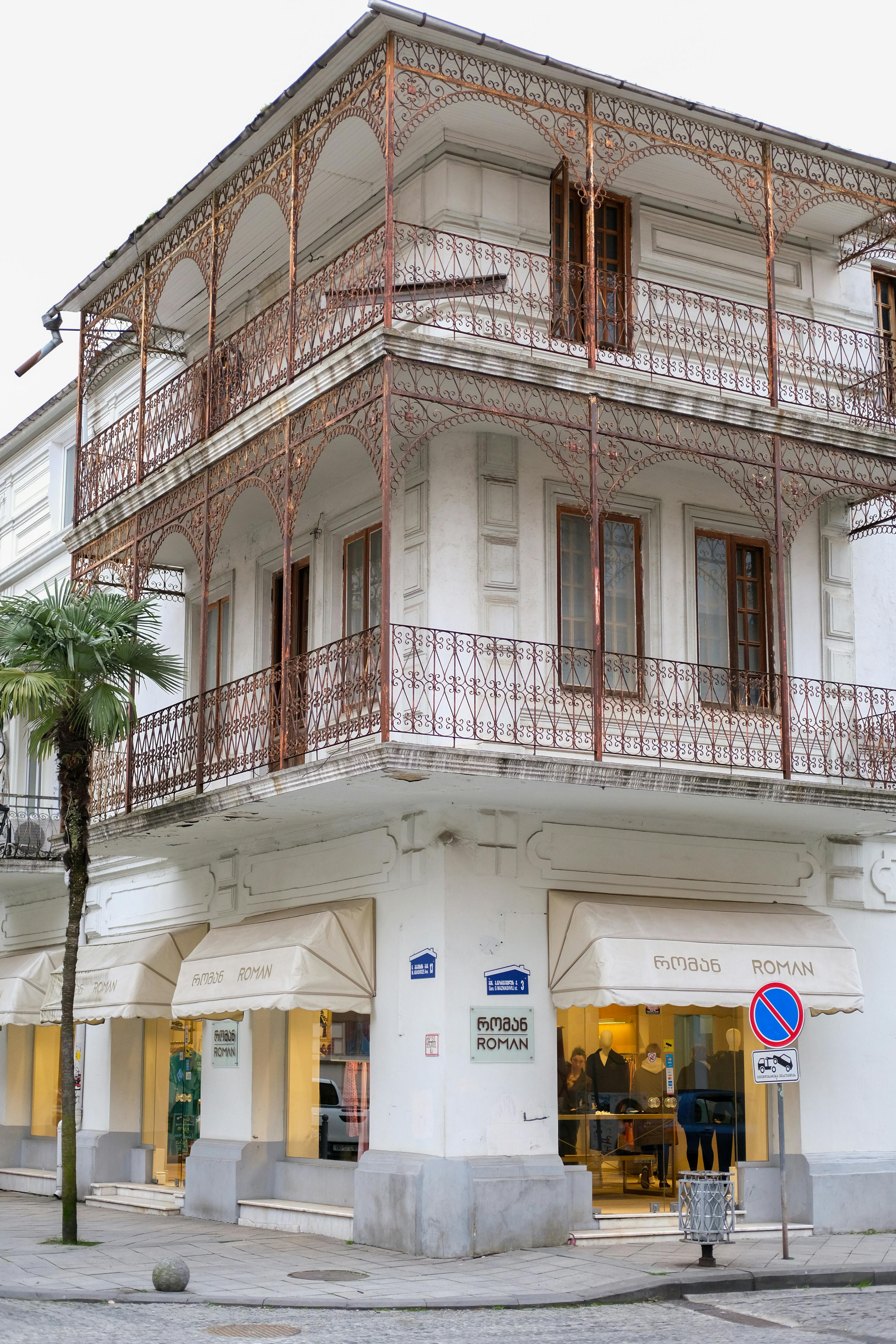White Building with Balconies on a Street Corner · Free Stock Photo