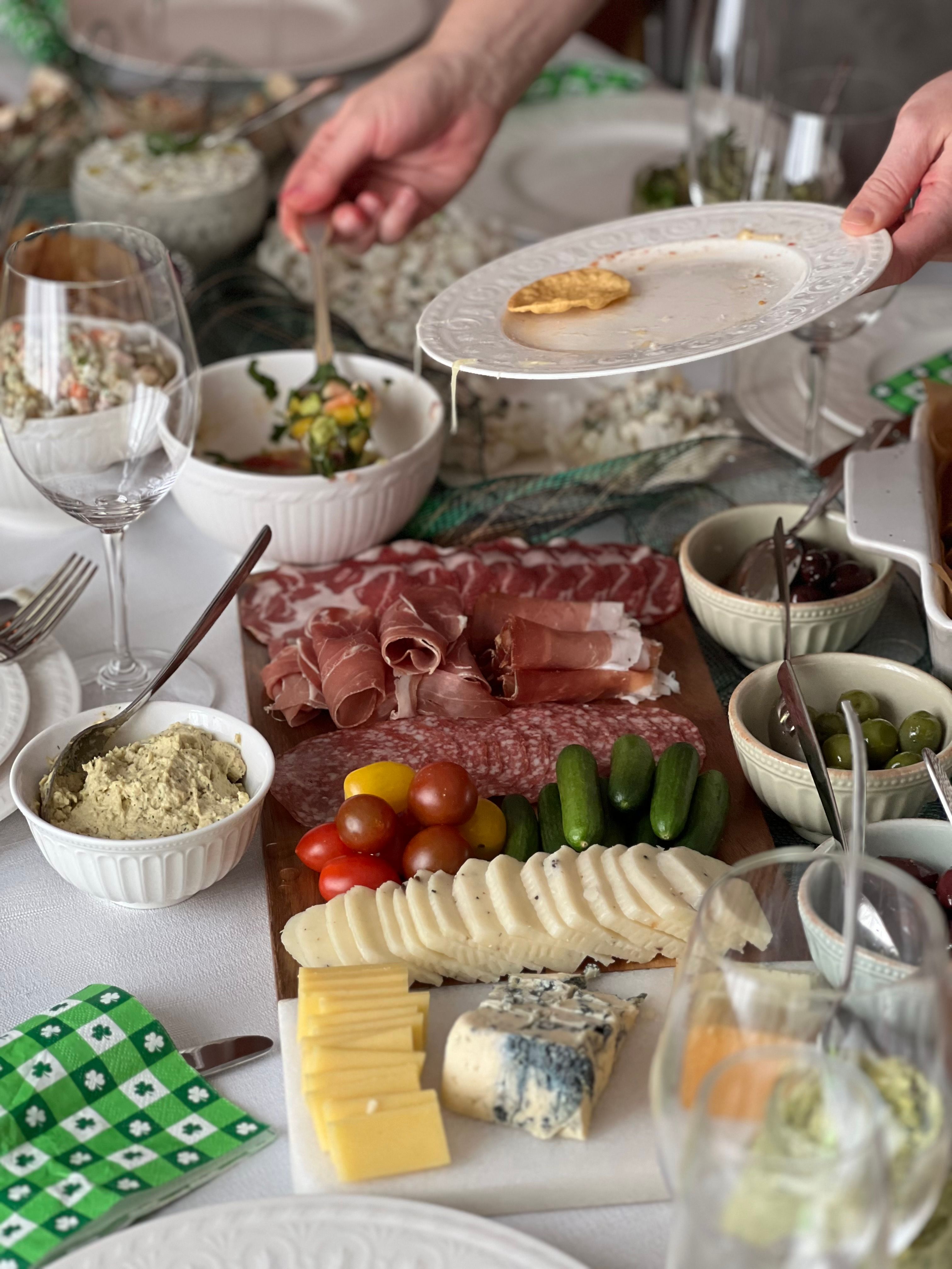 Getting Food at the Buffet Table · Free Stock Photo