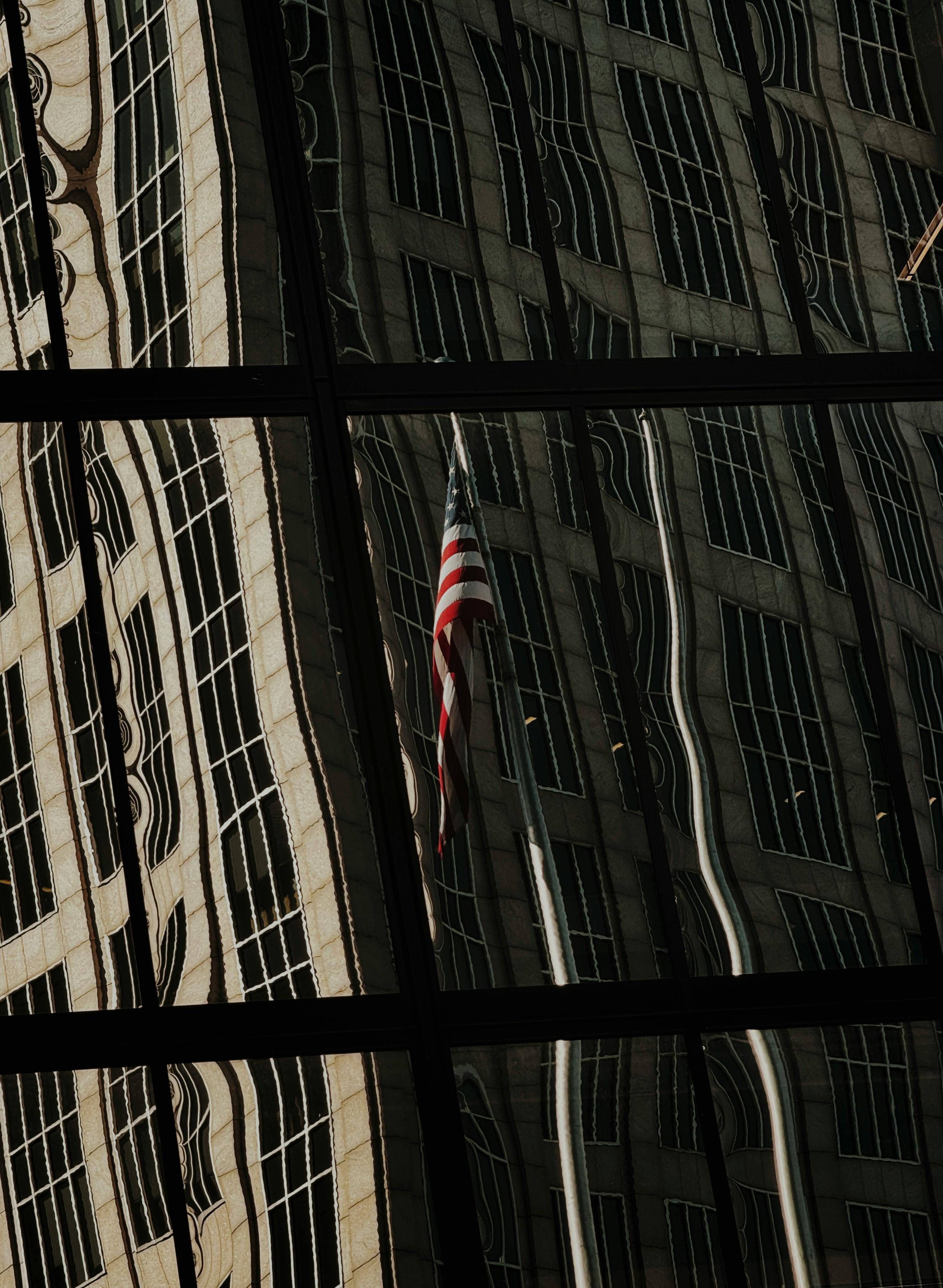 Reflection of American Flag and Tall Building · Free Stock Photo