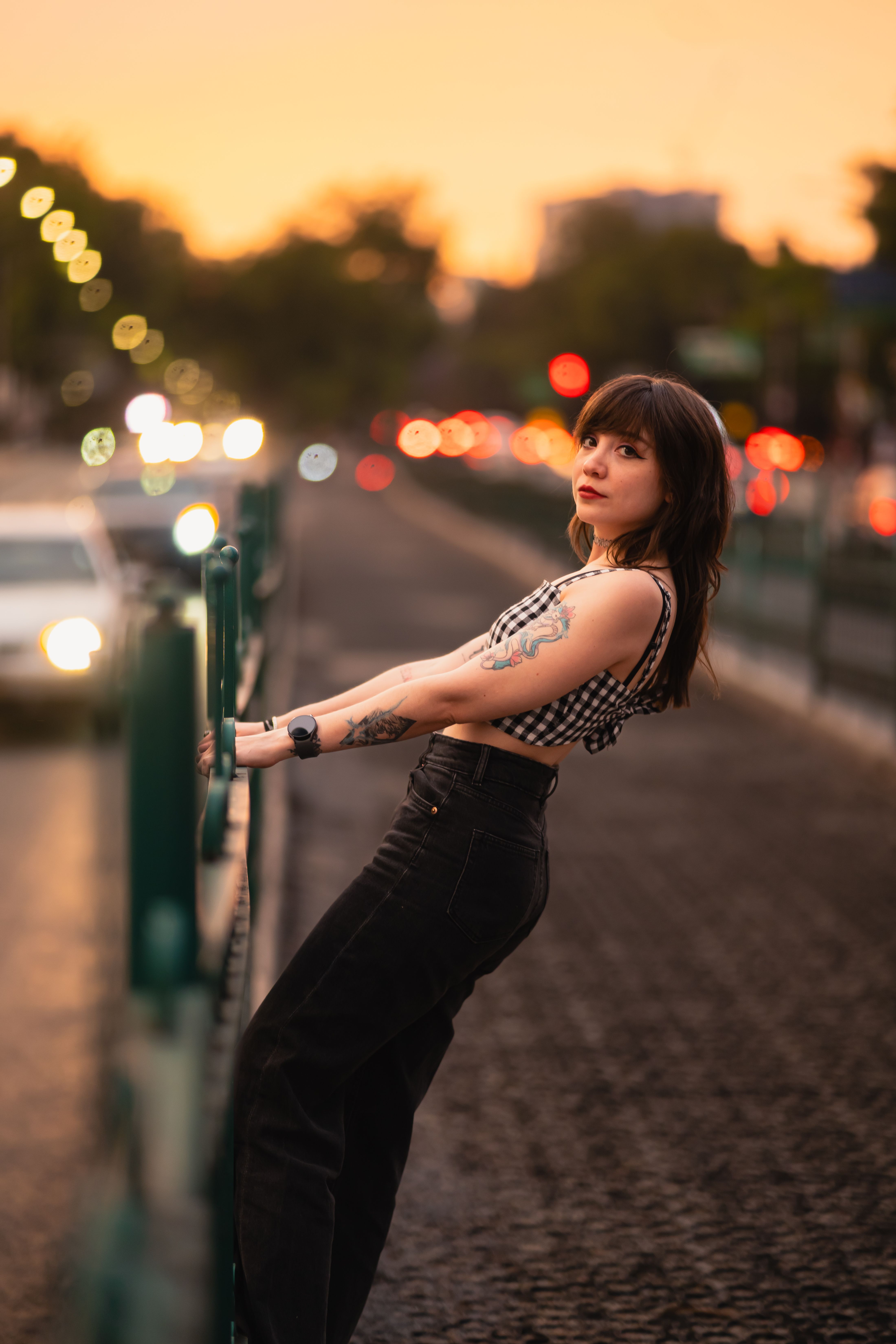 Woman Leaning on Railing on Sidewalk · Free Stock Photo