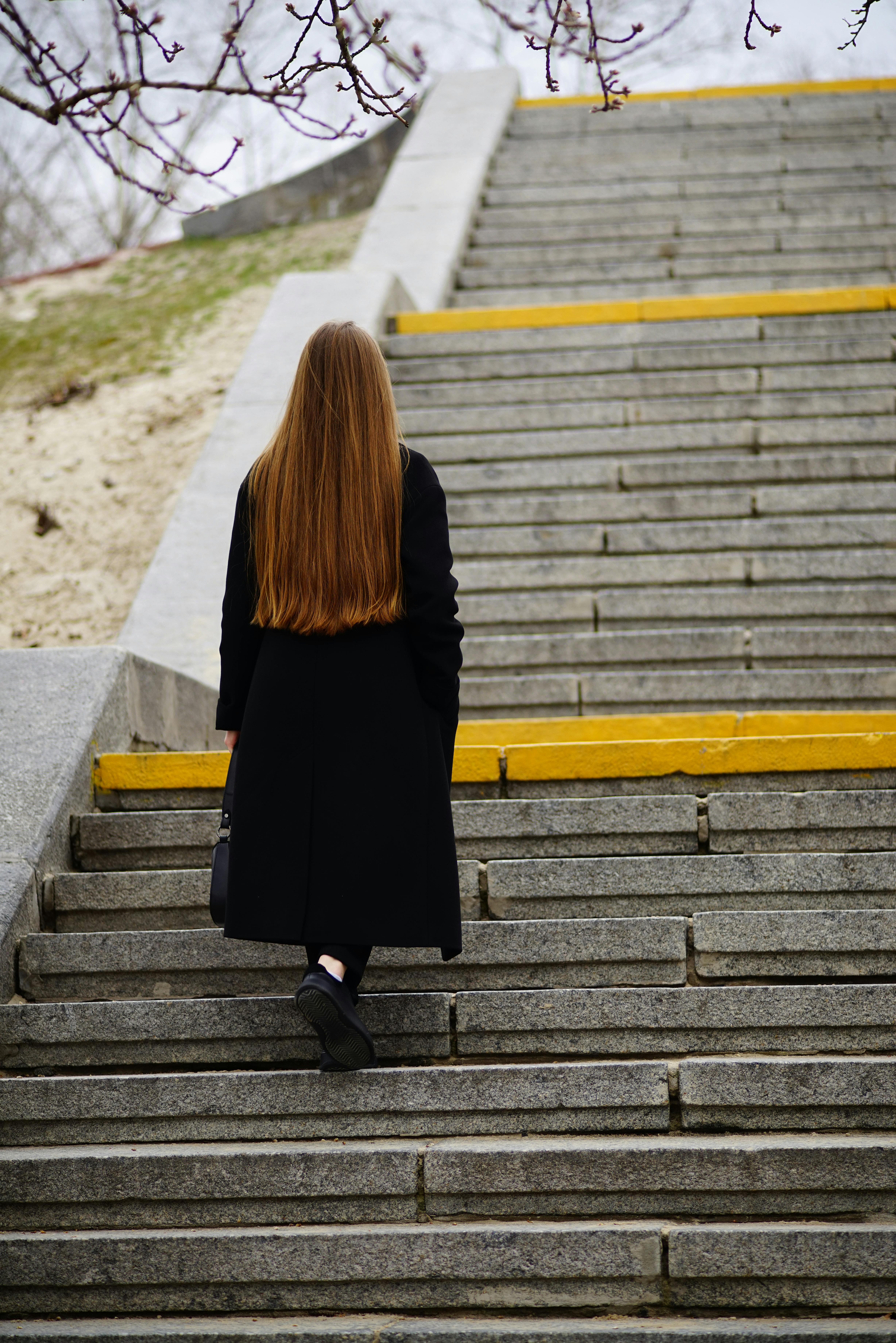Back View of a Woman Going Up the Stairs · Free Stock Photo
