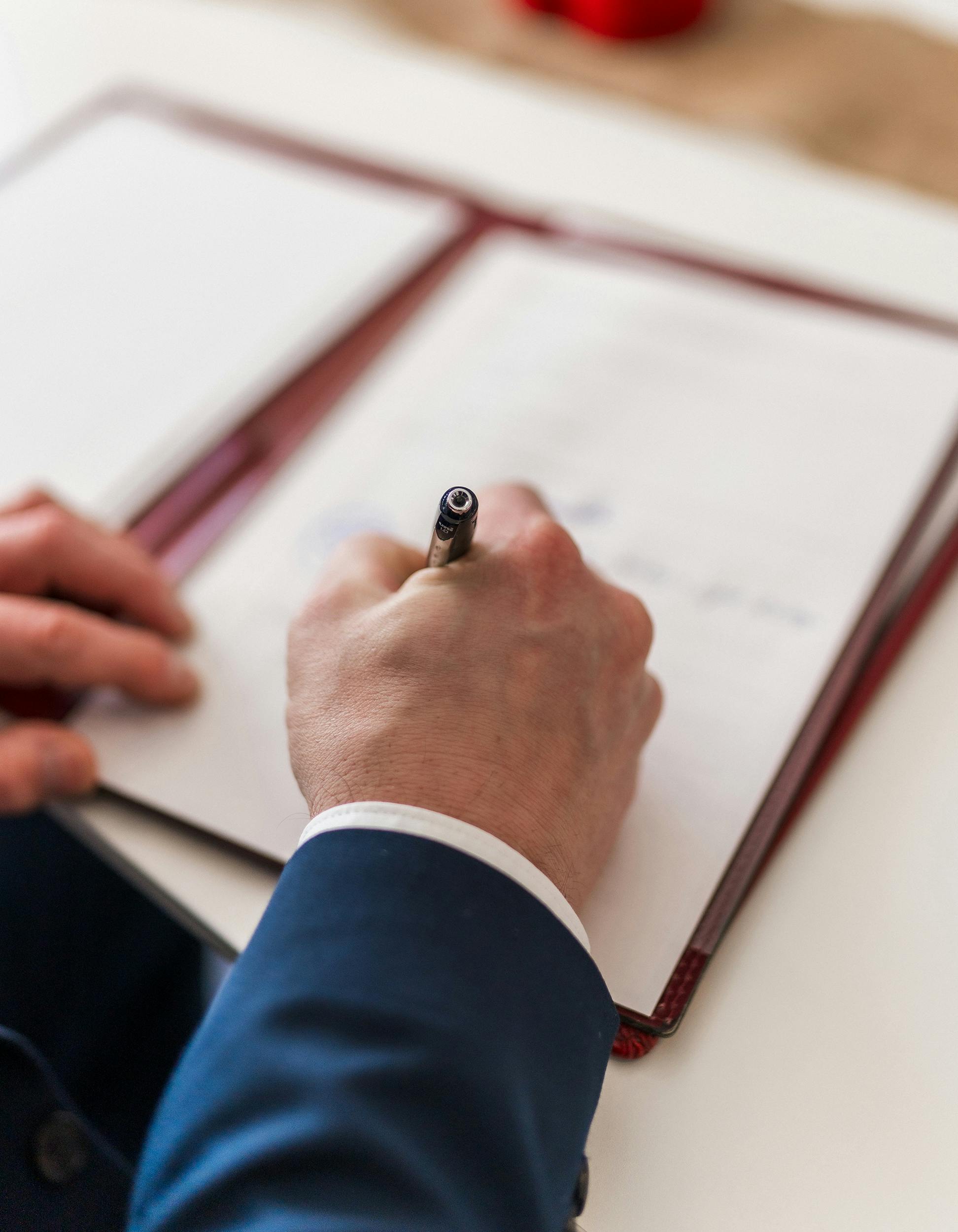 Person Signing Document Paper · Free Stock Photo
