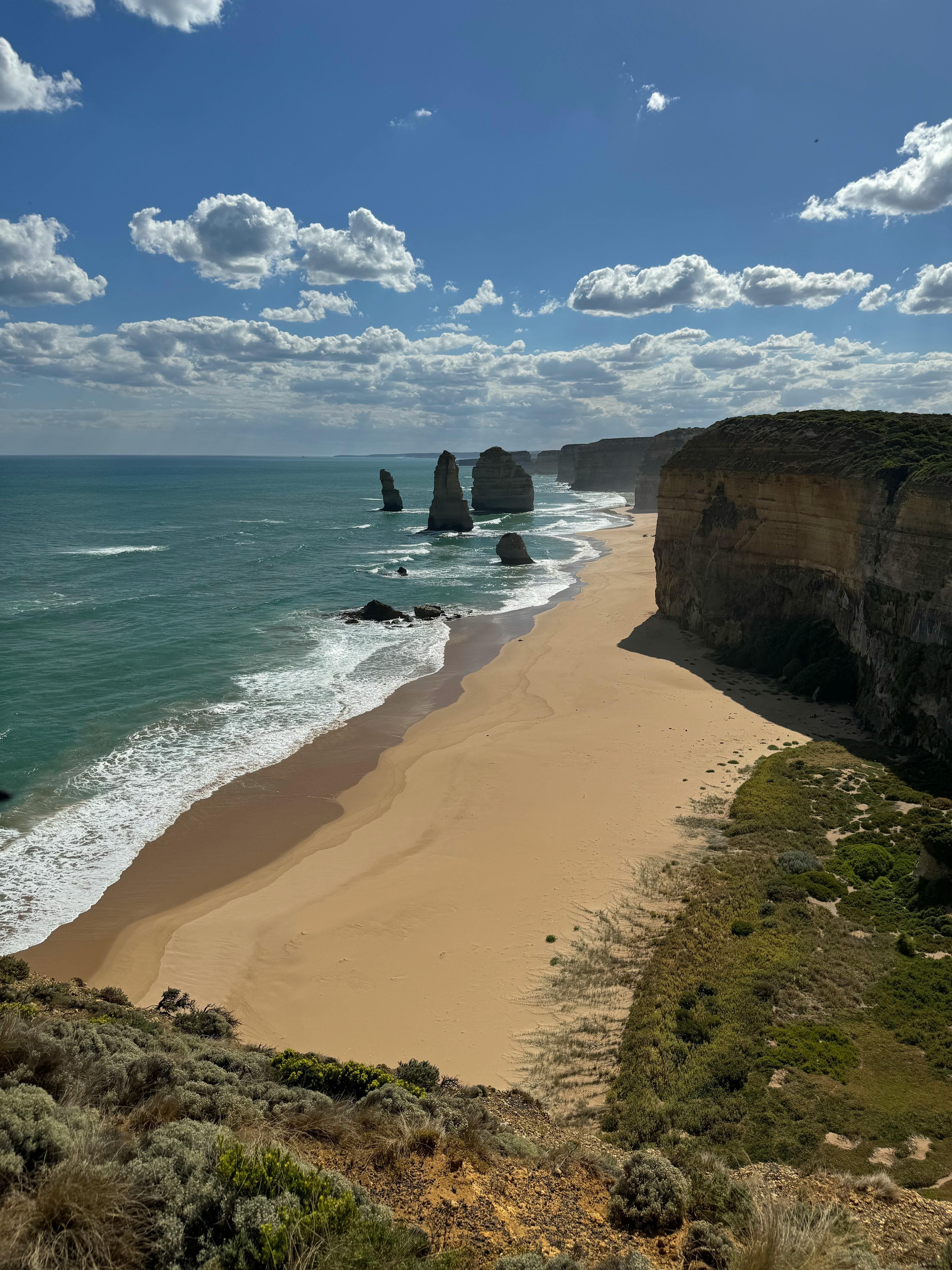 Brown Rock Formation on Sea Shore Under White Clouds · Free Stock Photo