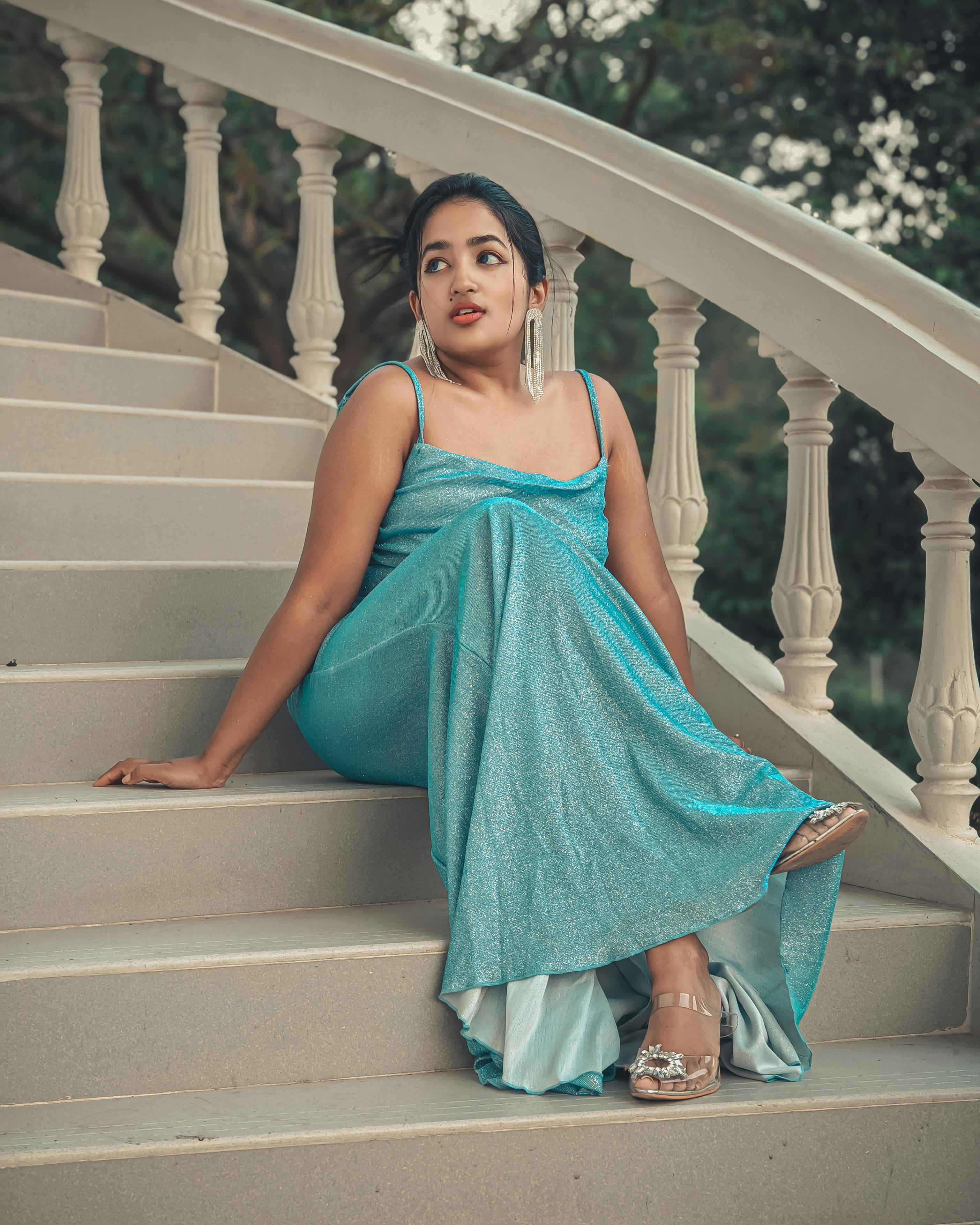 Brunette Woman Sitting in Blue Dress on Stairs · Free Stock Photo