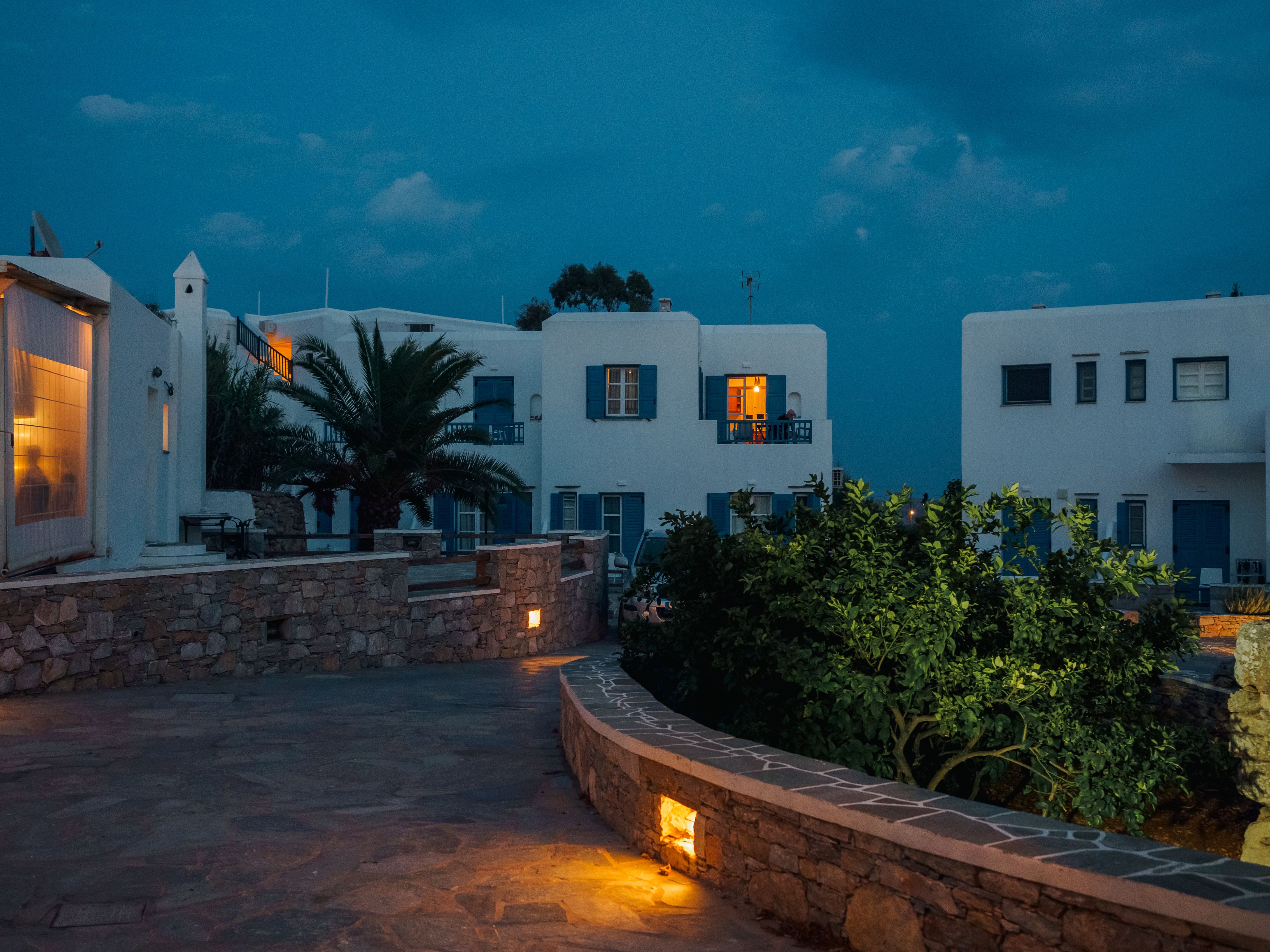 The exterior of a hotel at night with lights · Free Stock Photo