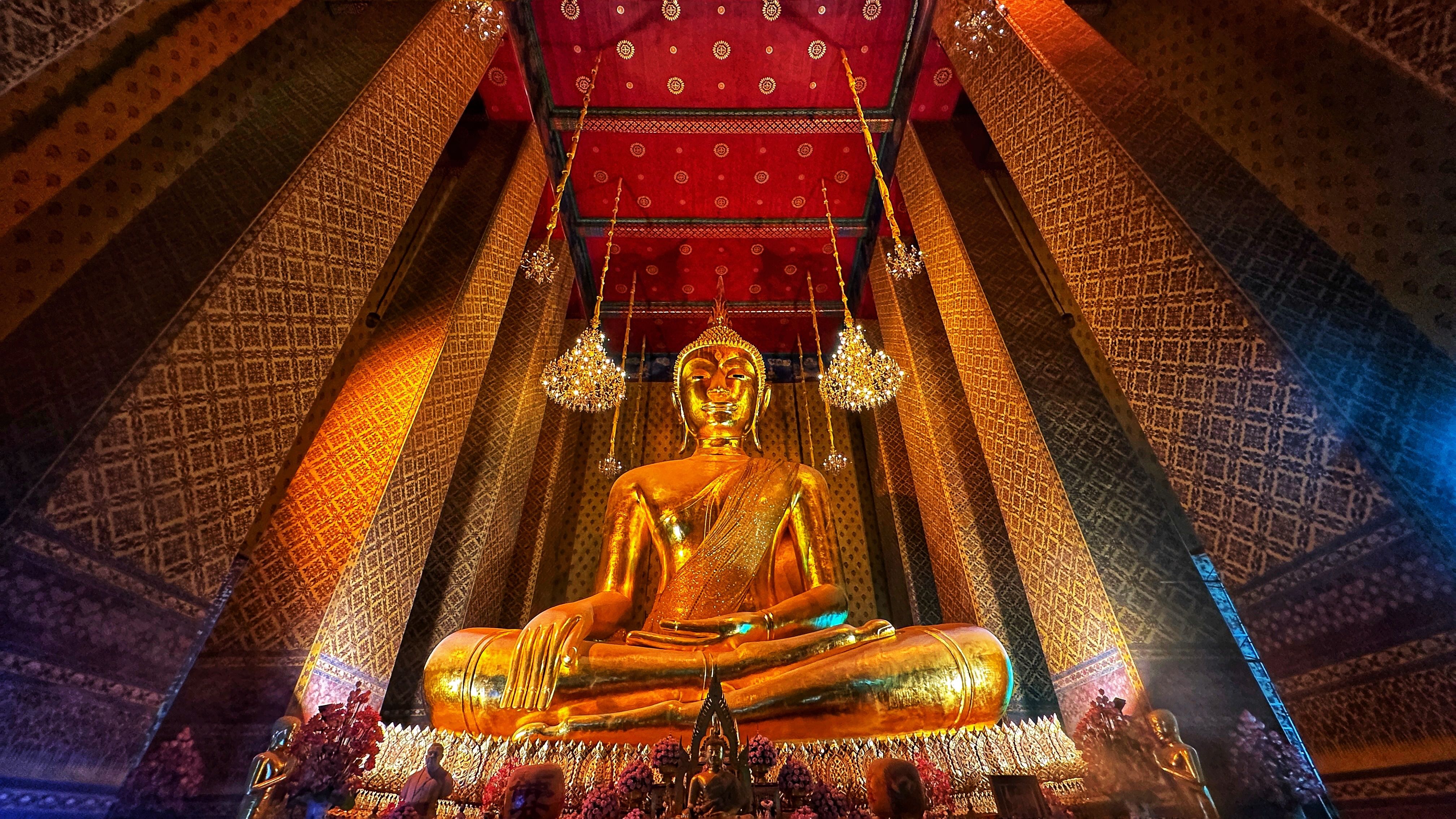 A buddha statue in a temple with red and gold decorations · Free Stock ...