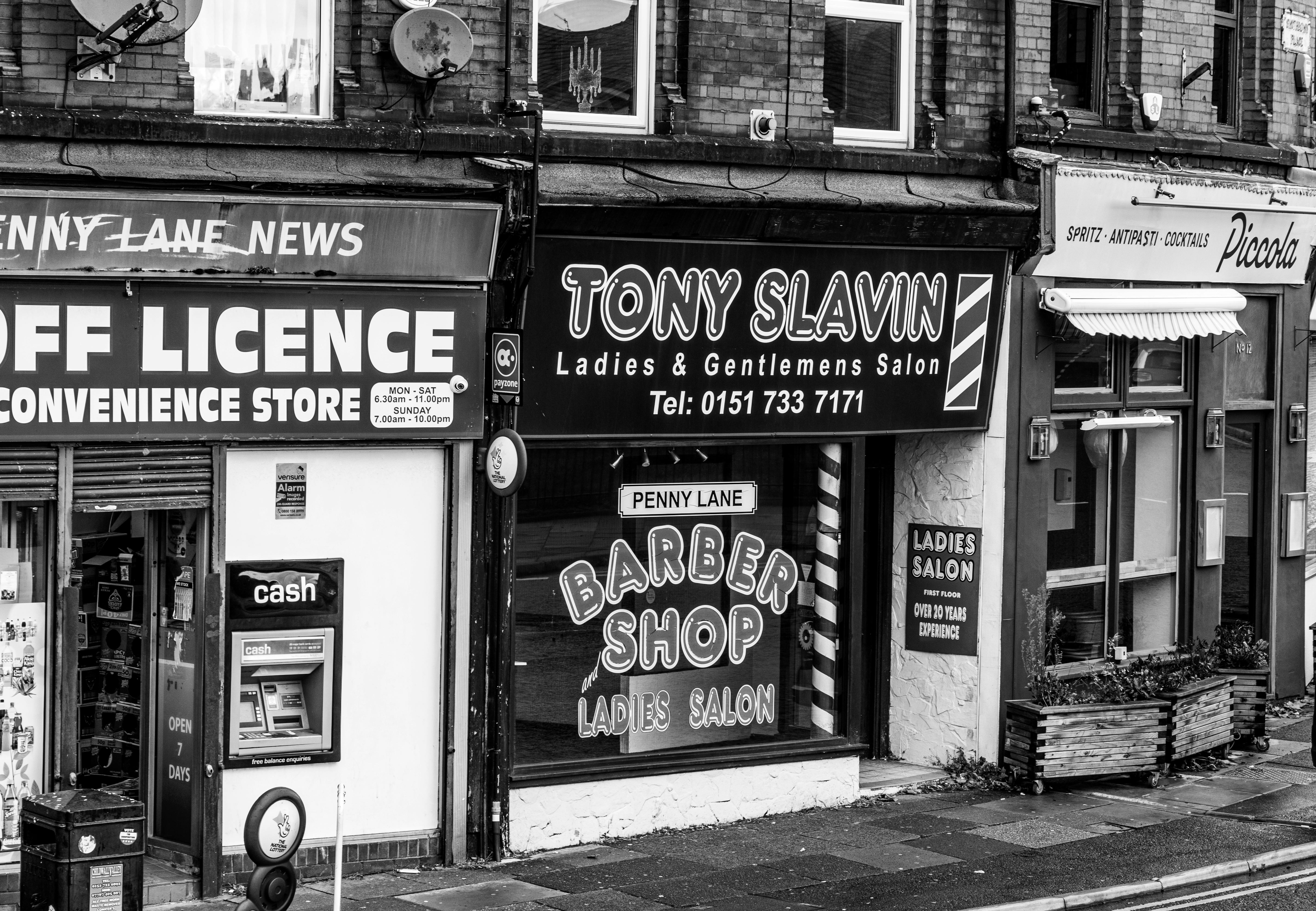 View of the "Tony Slavin" Barber Shop, a Store and a Restaurant in ...