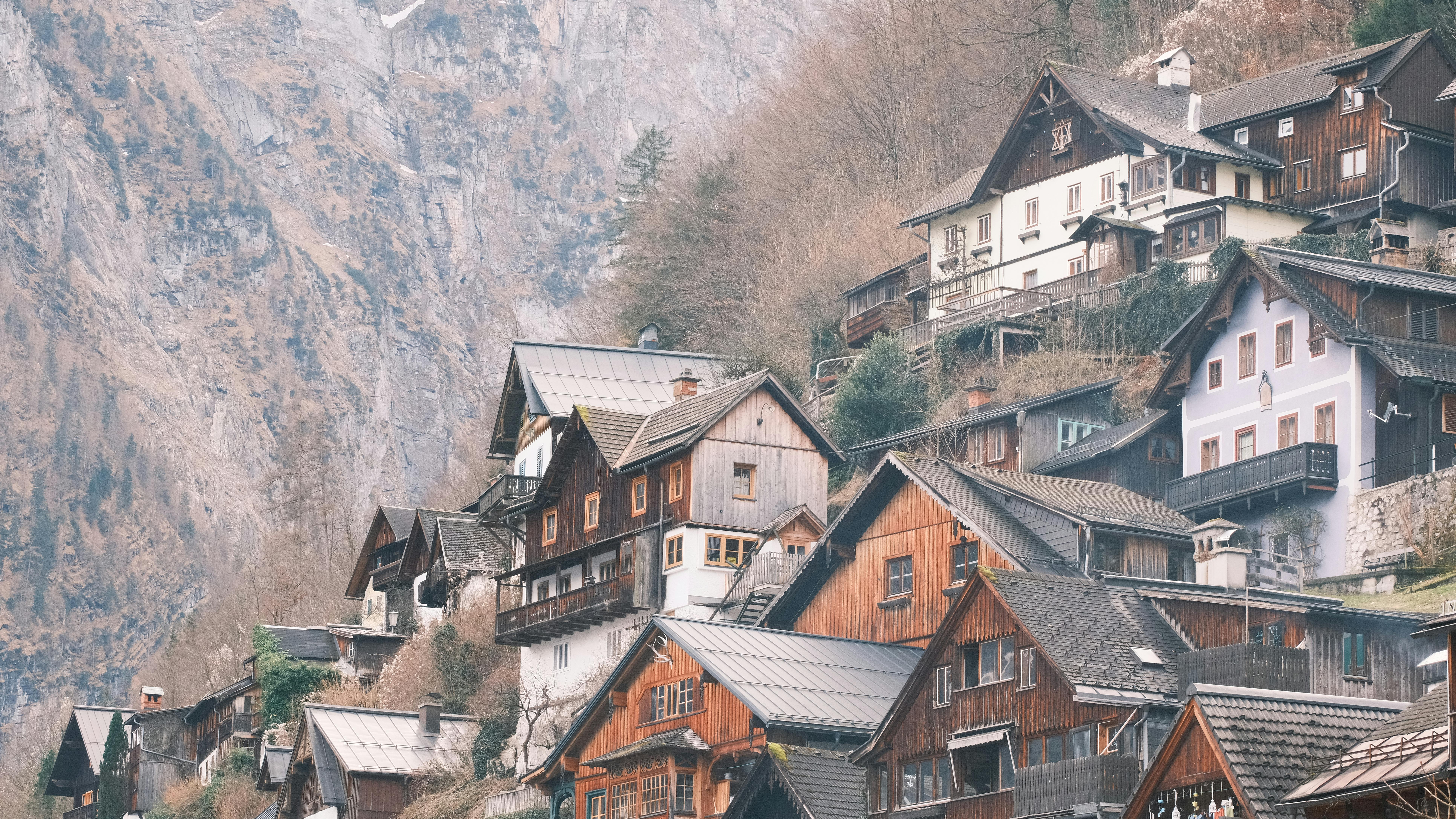 Charming wooden houses in the alpine village of Hallstatt, Austria, nestled against majestic mountains.