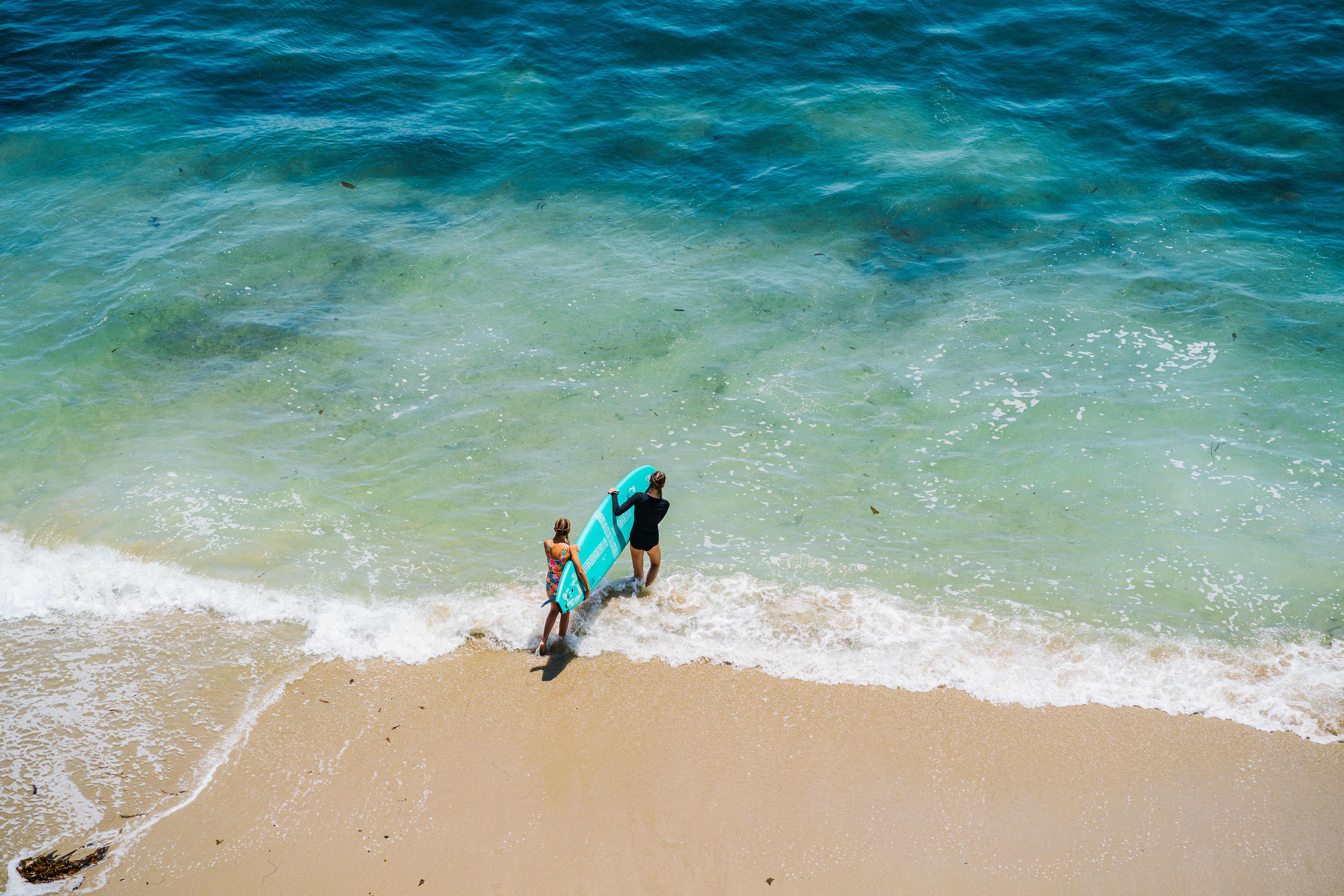 Two Surfers Going into the Ocean · Free Stock Photo