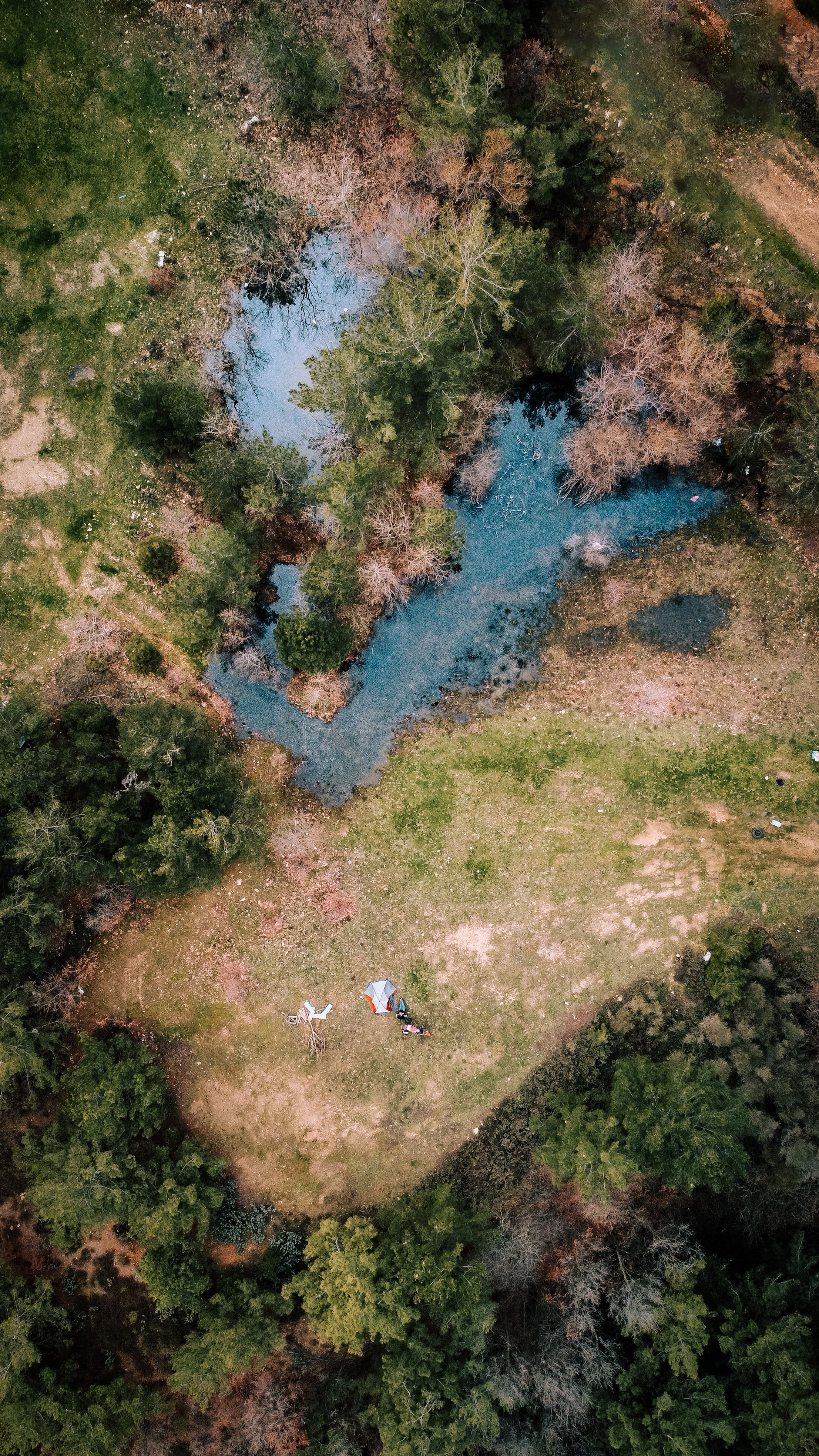 Aerial View of a Campsite in a Forest Clearing Near a Pond · Free Stock ...