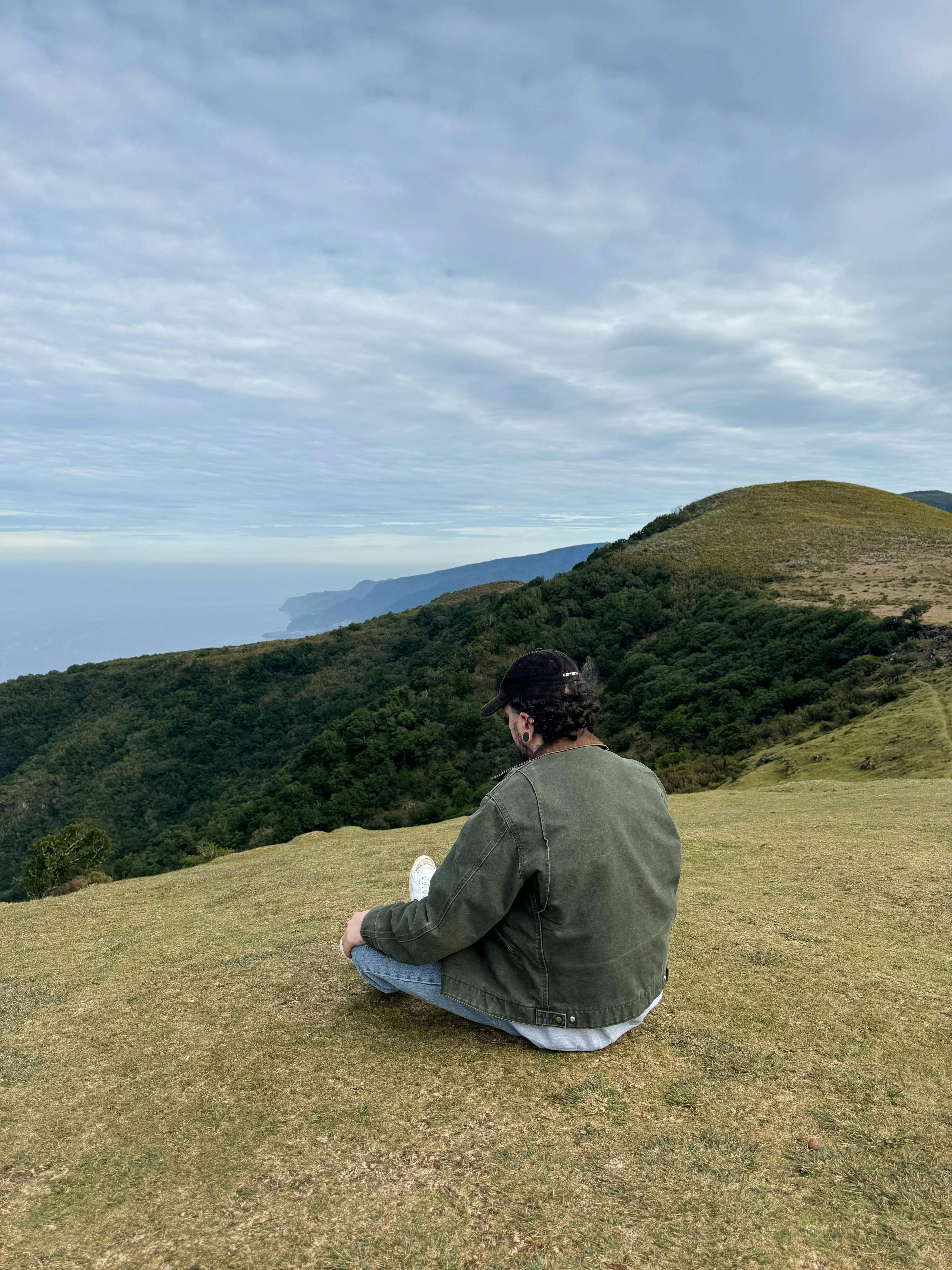 Side View Photo of Woman Sitting on Ground Overlooking a Hill · Free ...