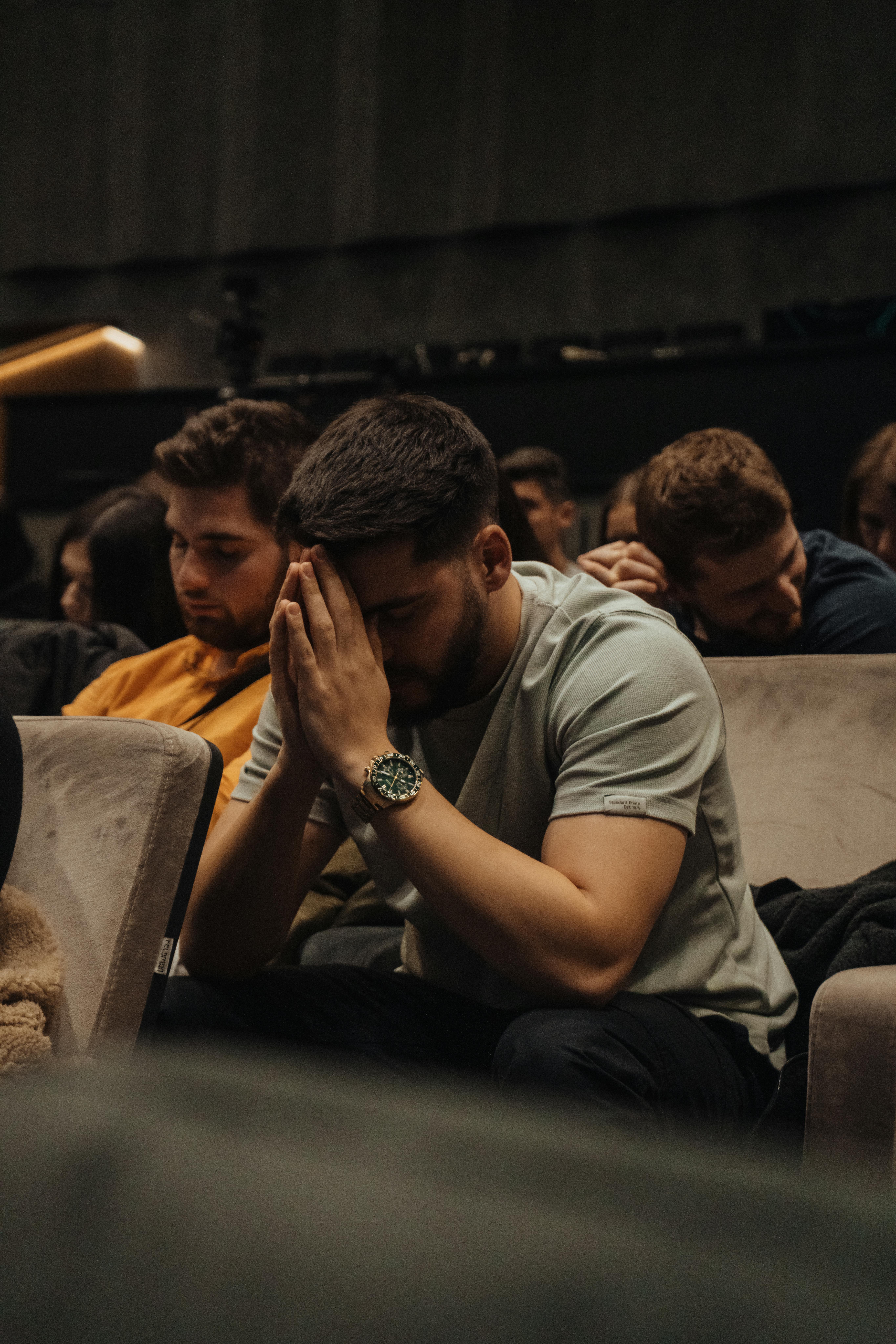 young man praying in church · Free Stock Photo