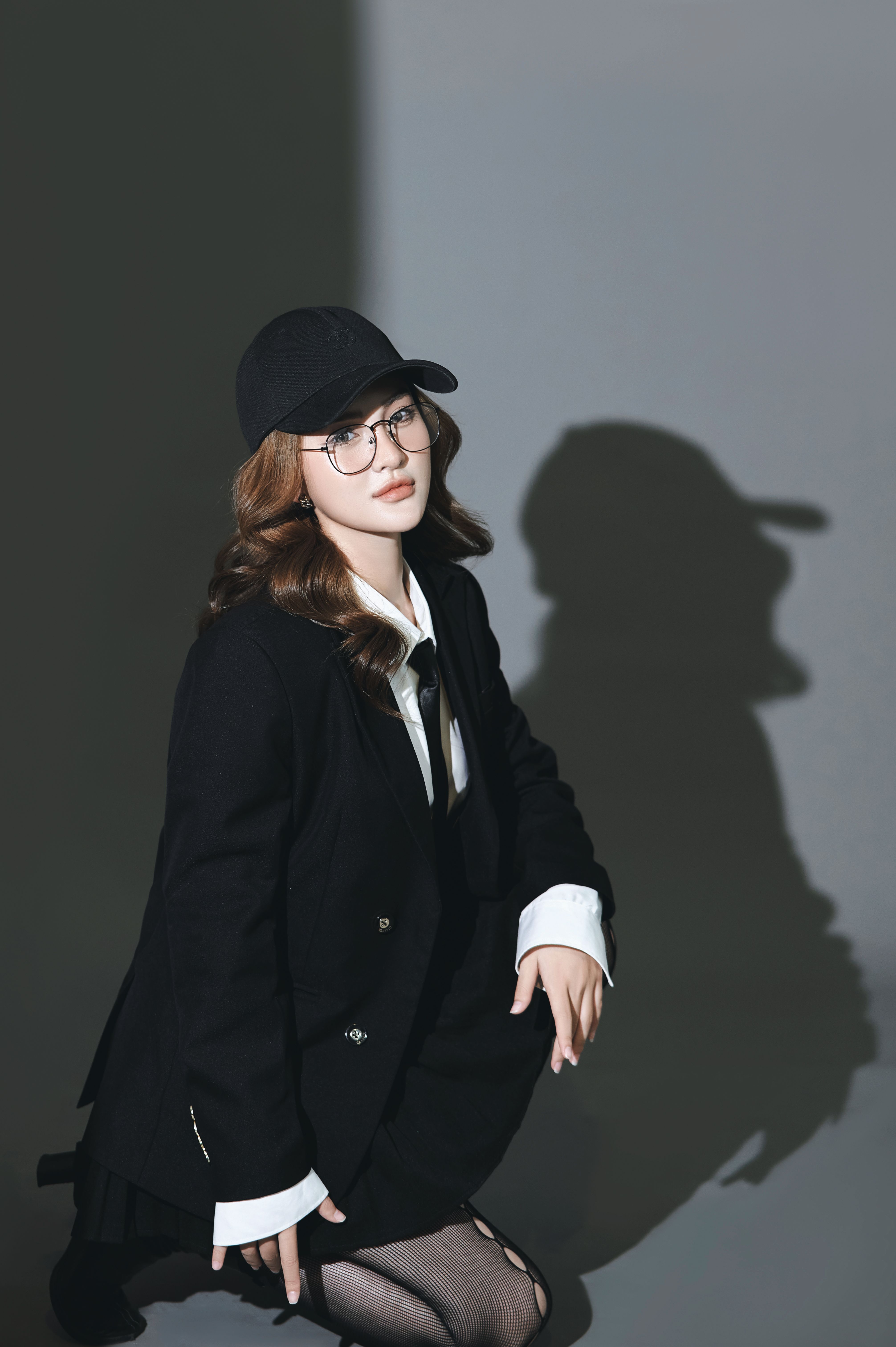 Woman Kneeling in Cap and Black Suit · Free Stock Photo