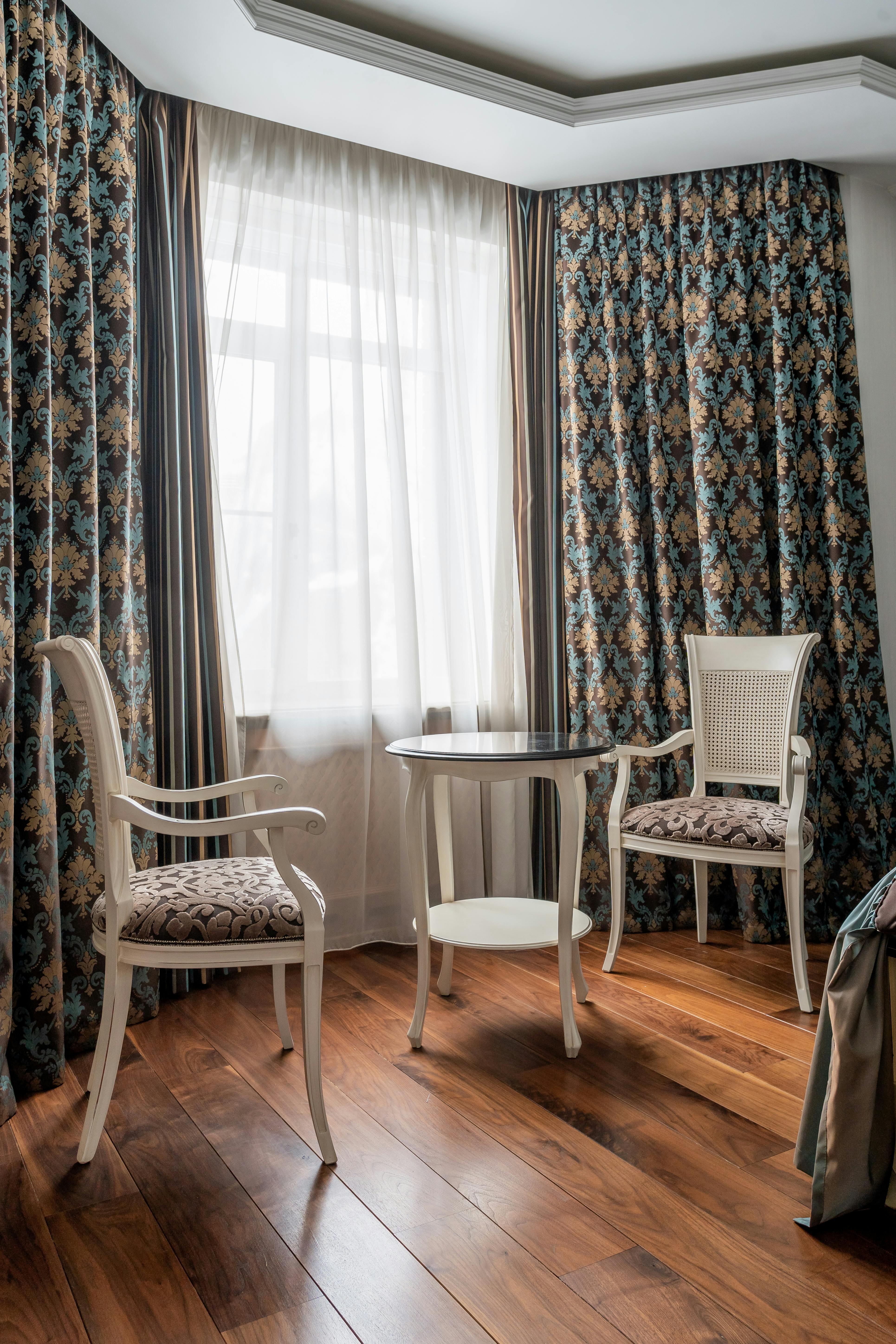 A Table and Chairs Standing near a Window in a Room with Vintage Design ...