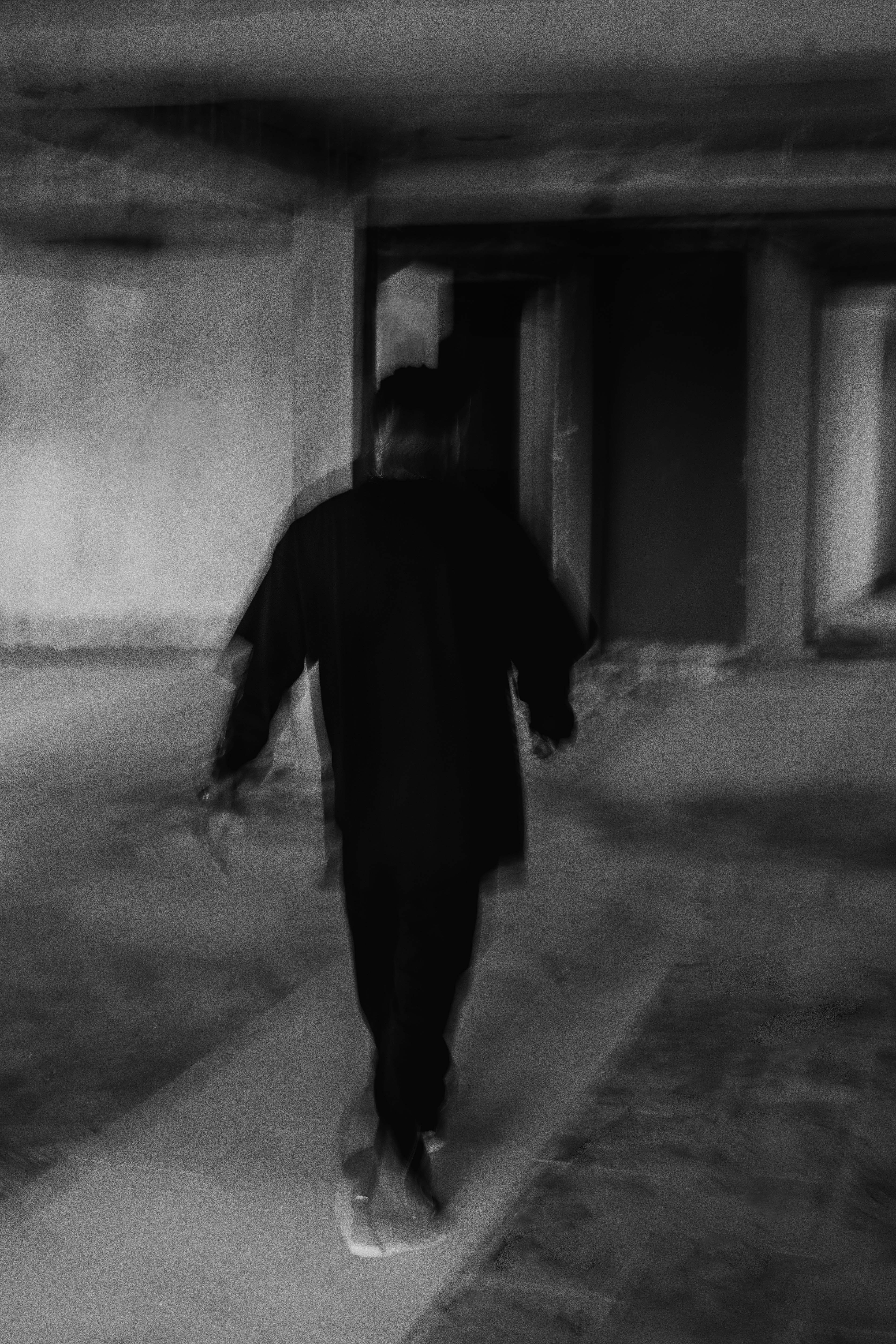 Blurry Black and White Photo of a Person Walking in an Abandoned ...
