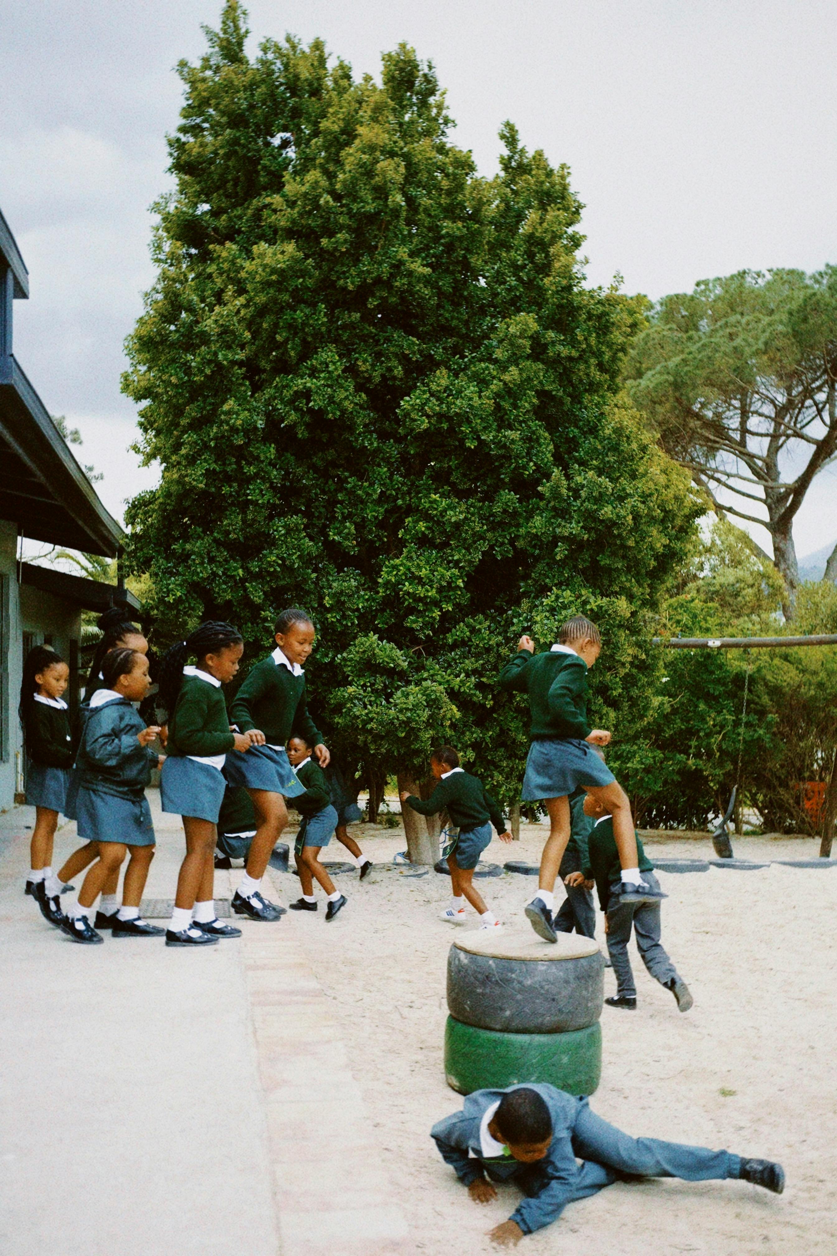 Photo of Schoolkids in Uniforms Playing on a Playground · Free Stock Photo