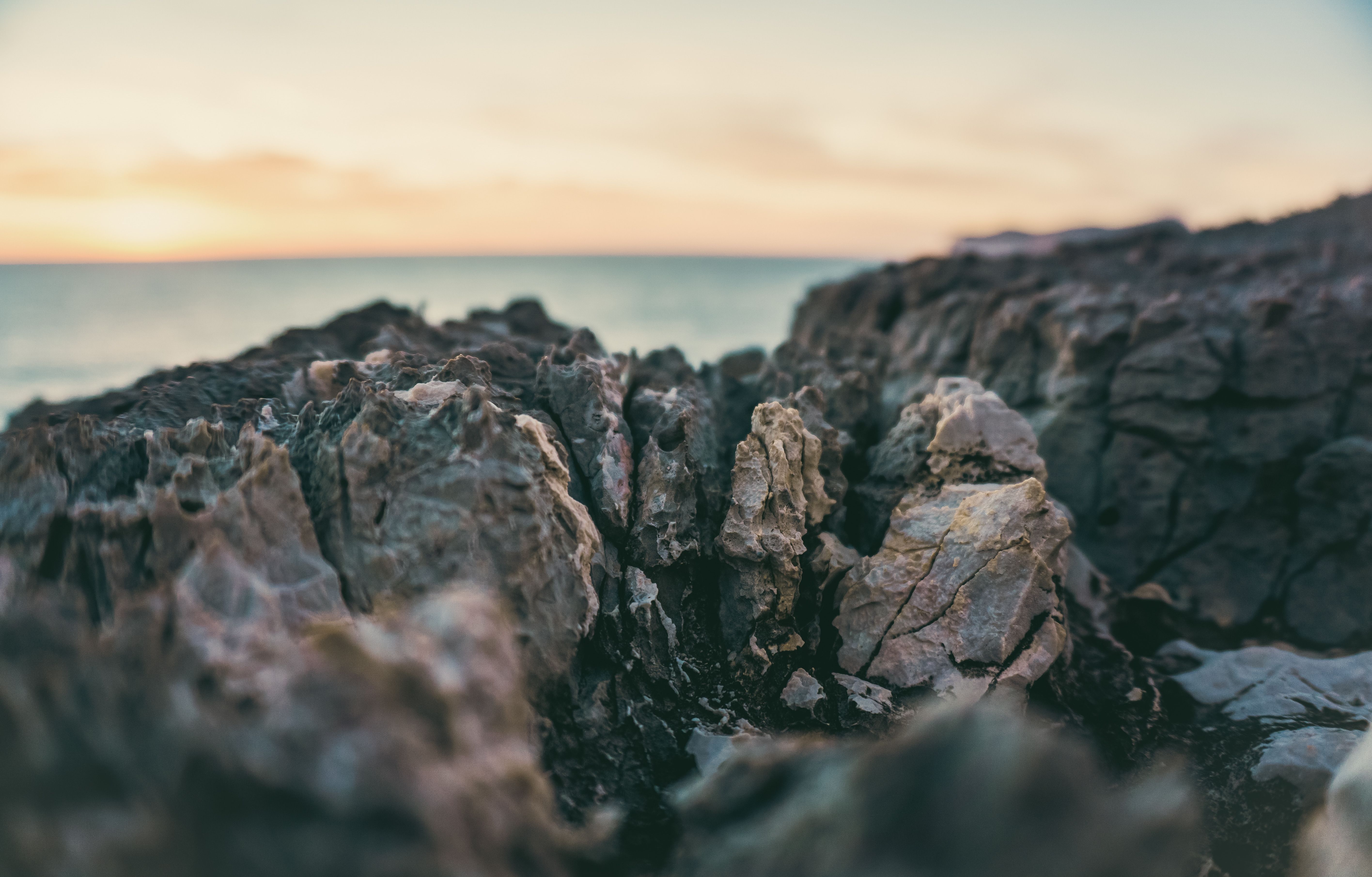 Close-up of Rock Formations on the Shore at Sunset · Free Stock Photo