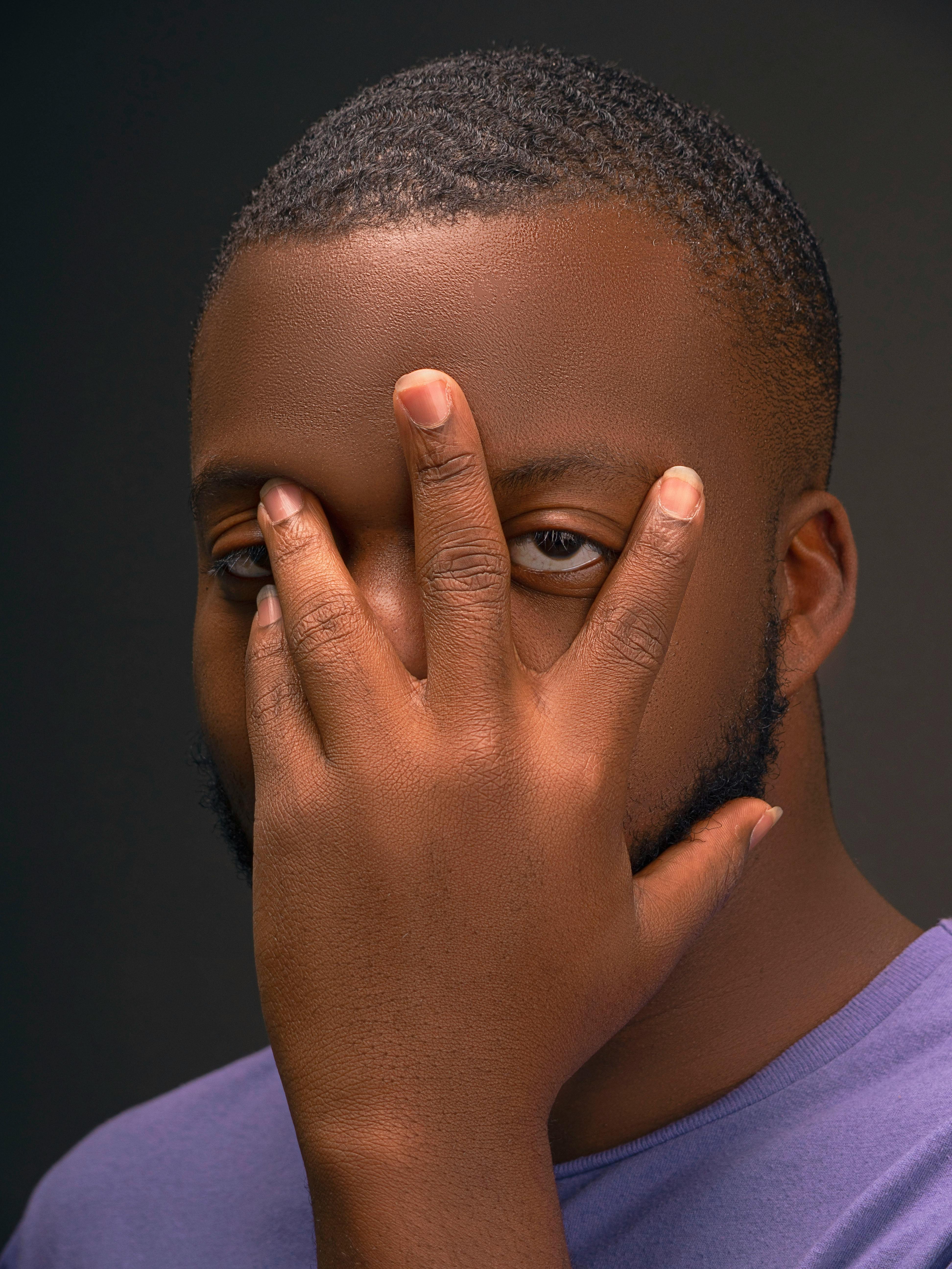 Portrait of a Young Man Covering His Face with a Hand · Free Stock Photo