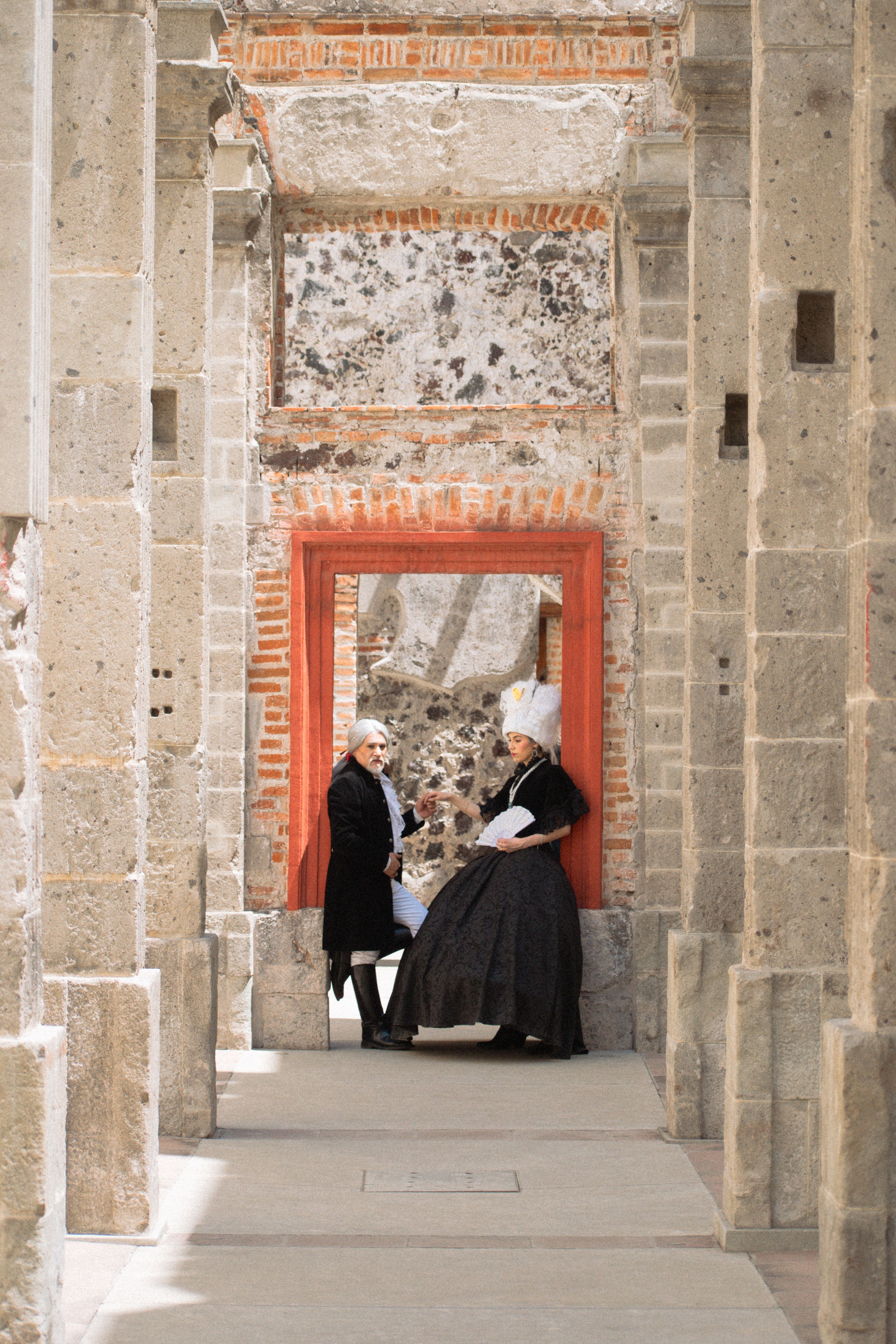 Woman and Man in Costumes Standing between Building Walls · Free Stock ...