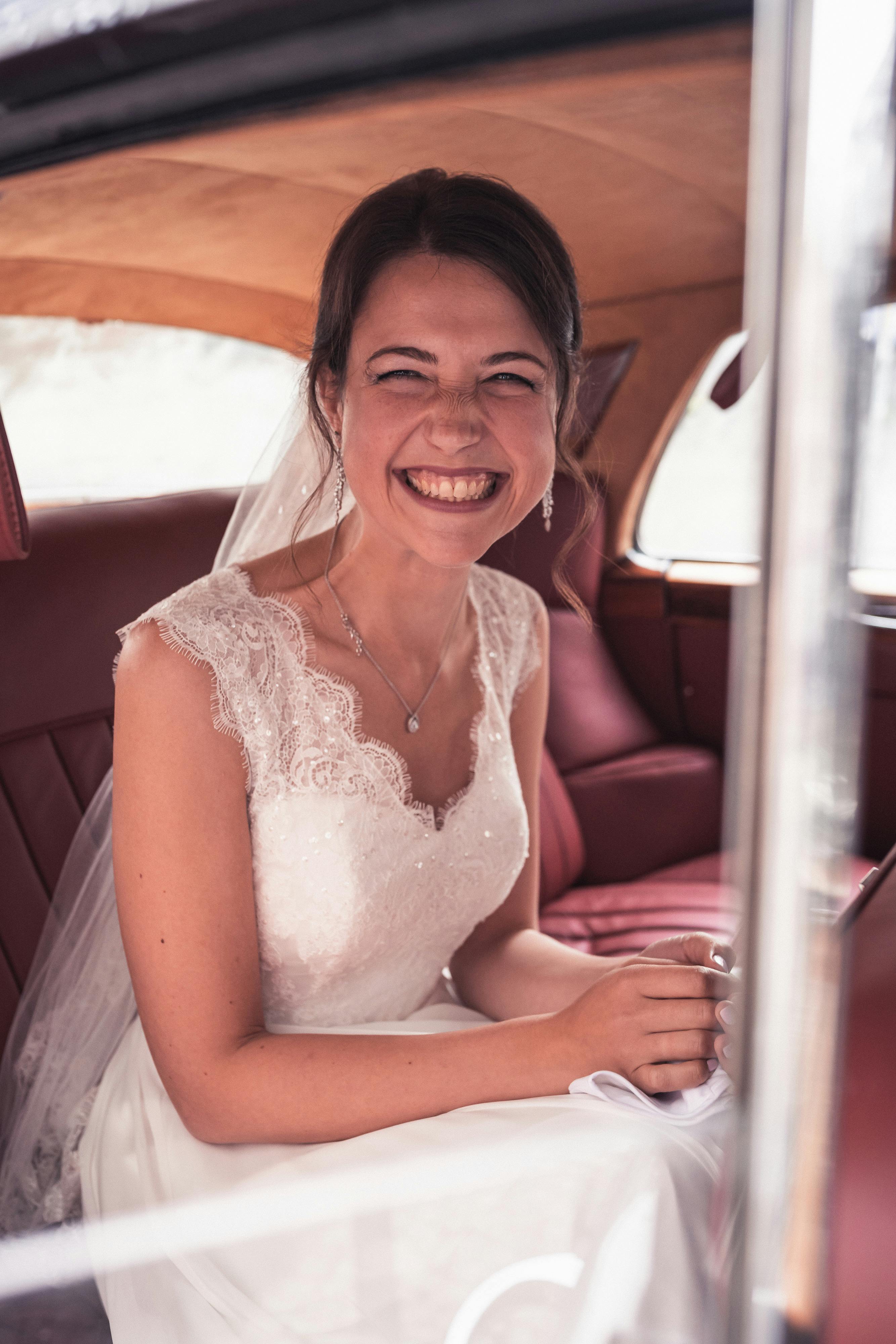 Smiling Bride Sitting in Car · Free Stock Photo