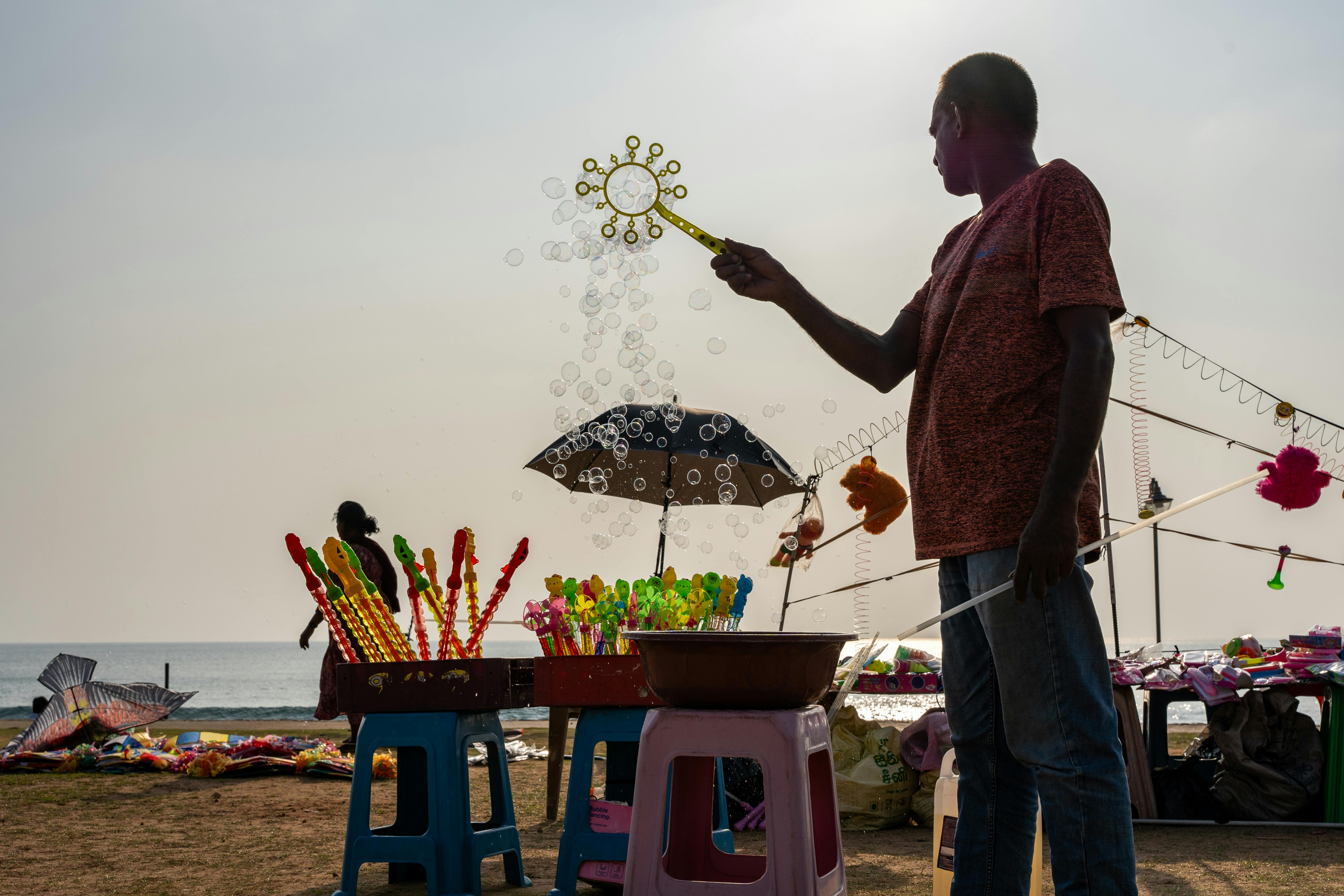 Man Blowing Bubbles on Beach · Free Stock Photo