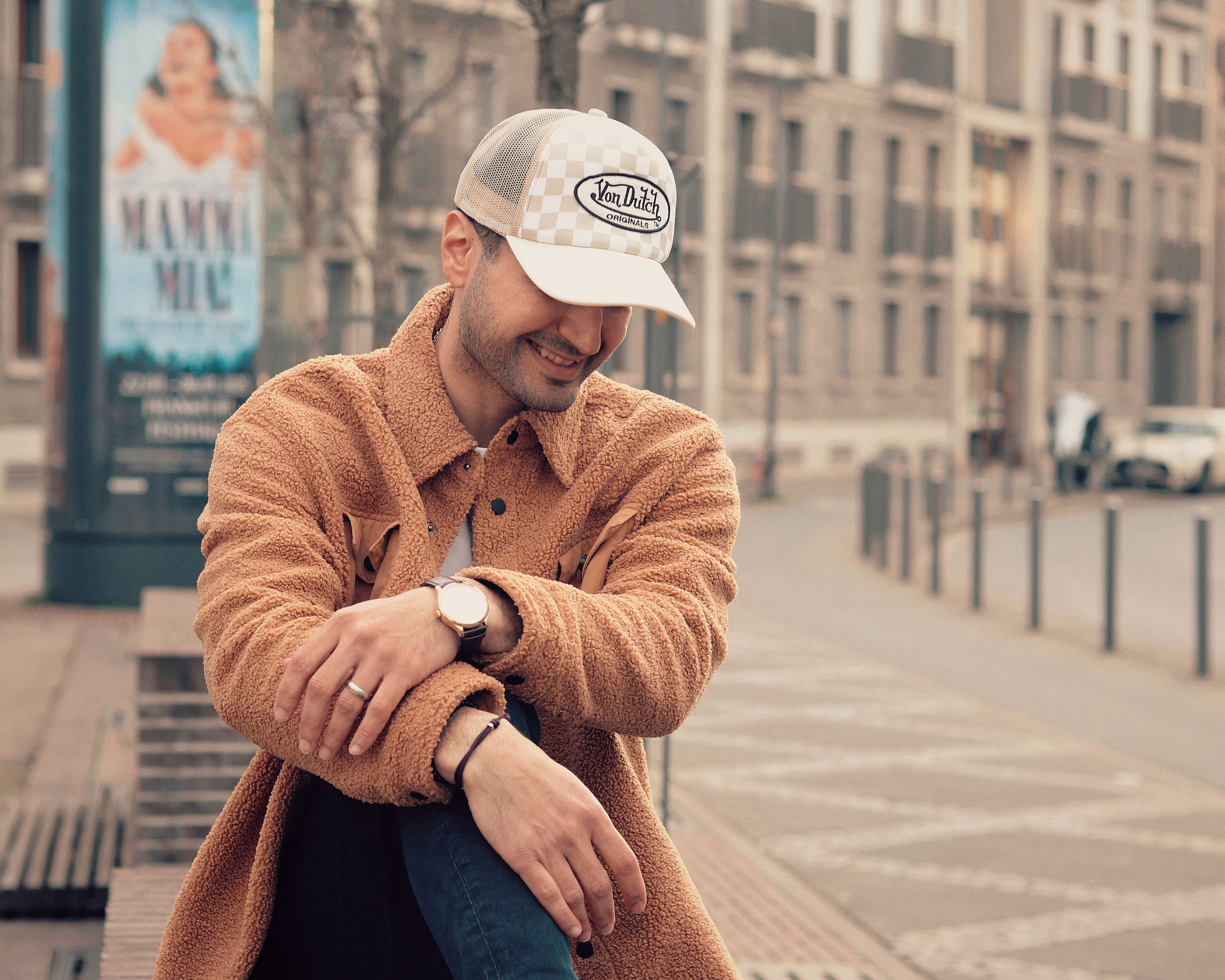 Man Wearing White Cap and Orange Fleece in City · Free Stock Photo