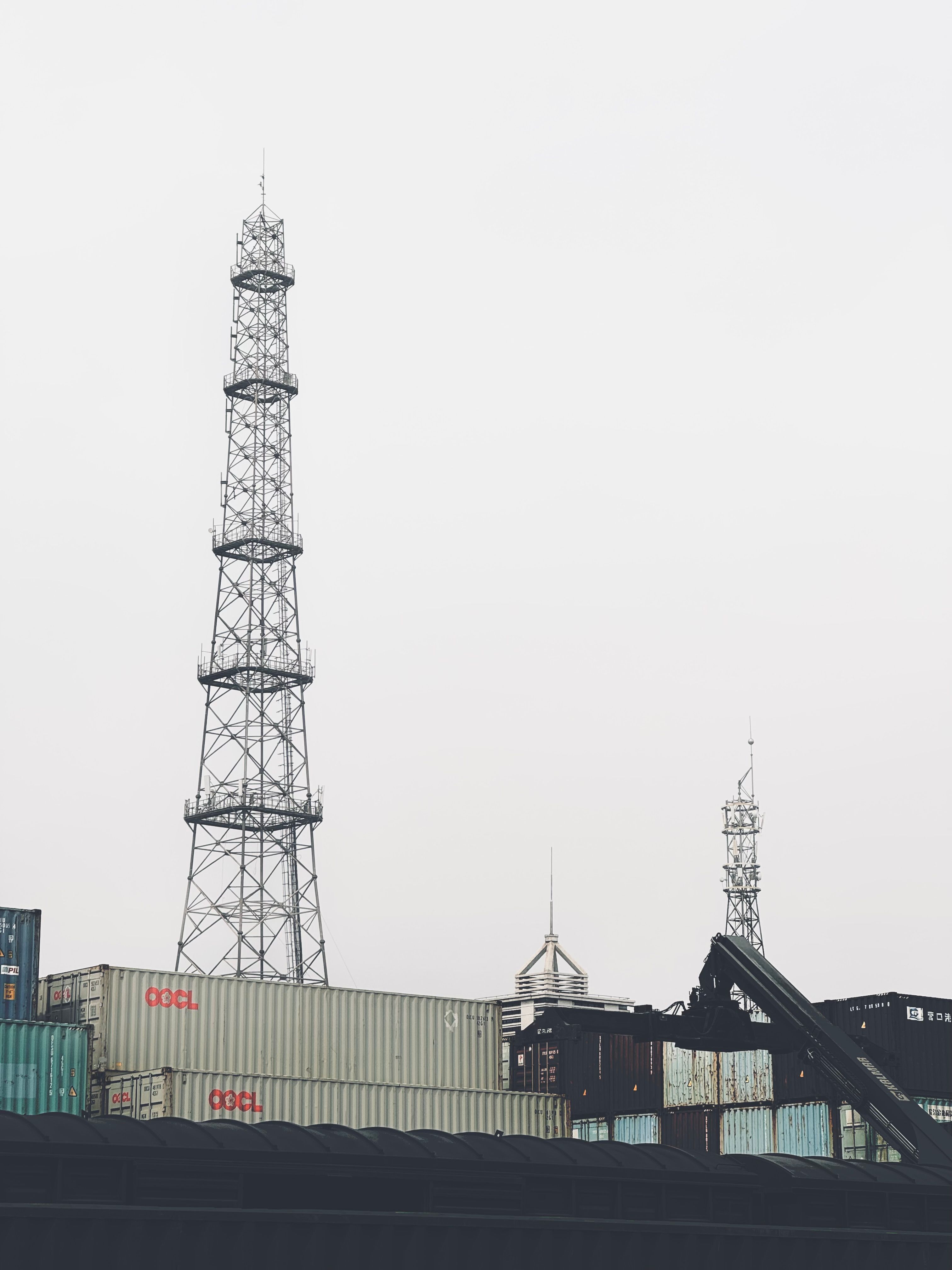 Containers and Transmission Tower in Warehouse · Free Stock Photo