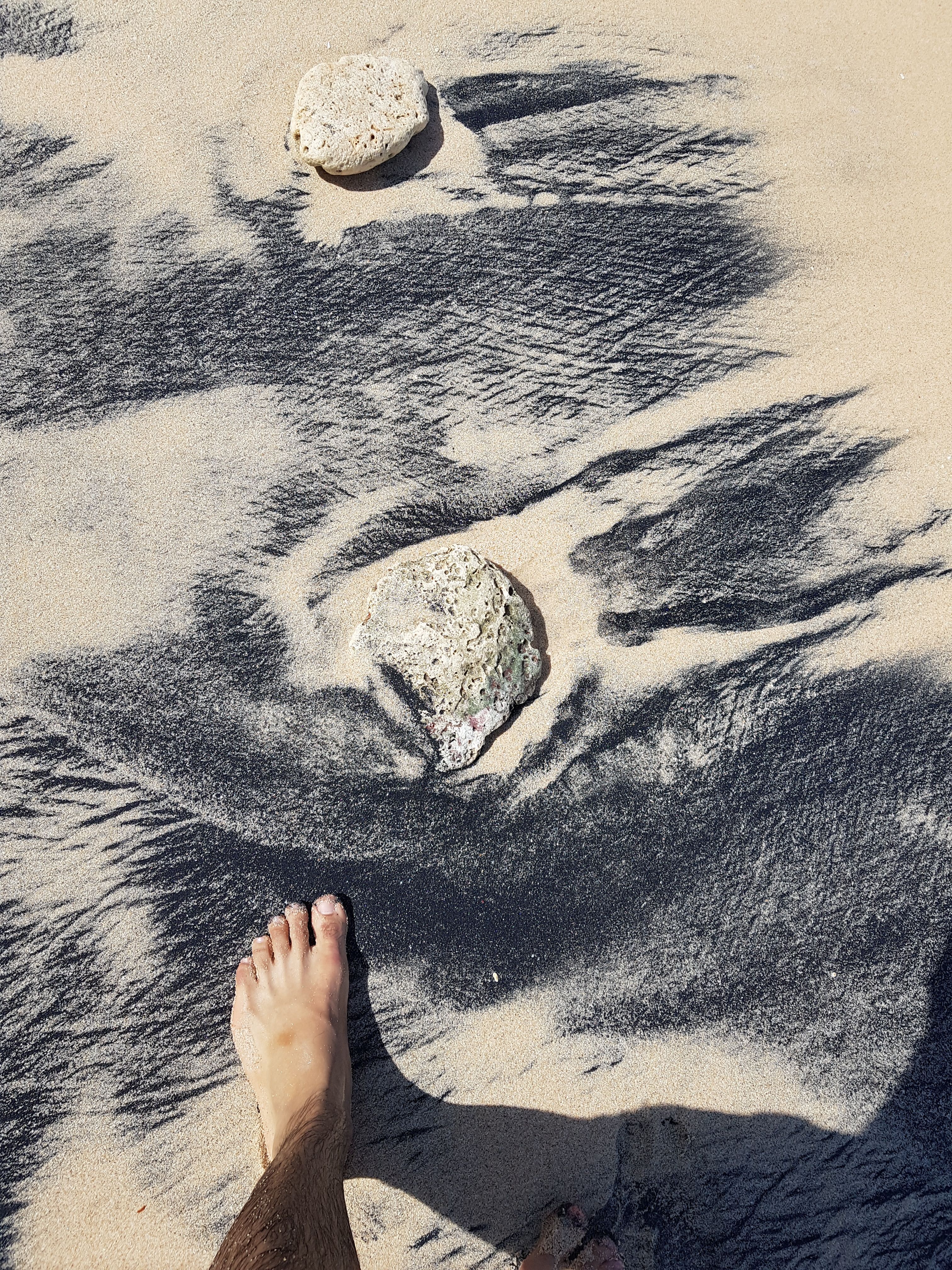 Person's Foot on Sand Near Rock · Free Stock Photo