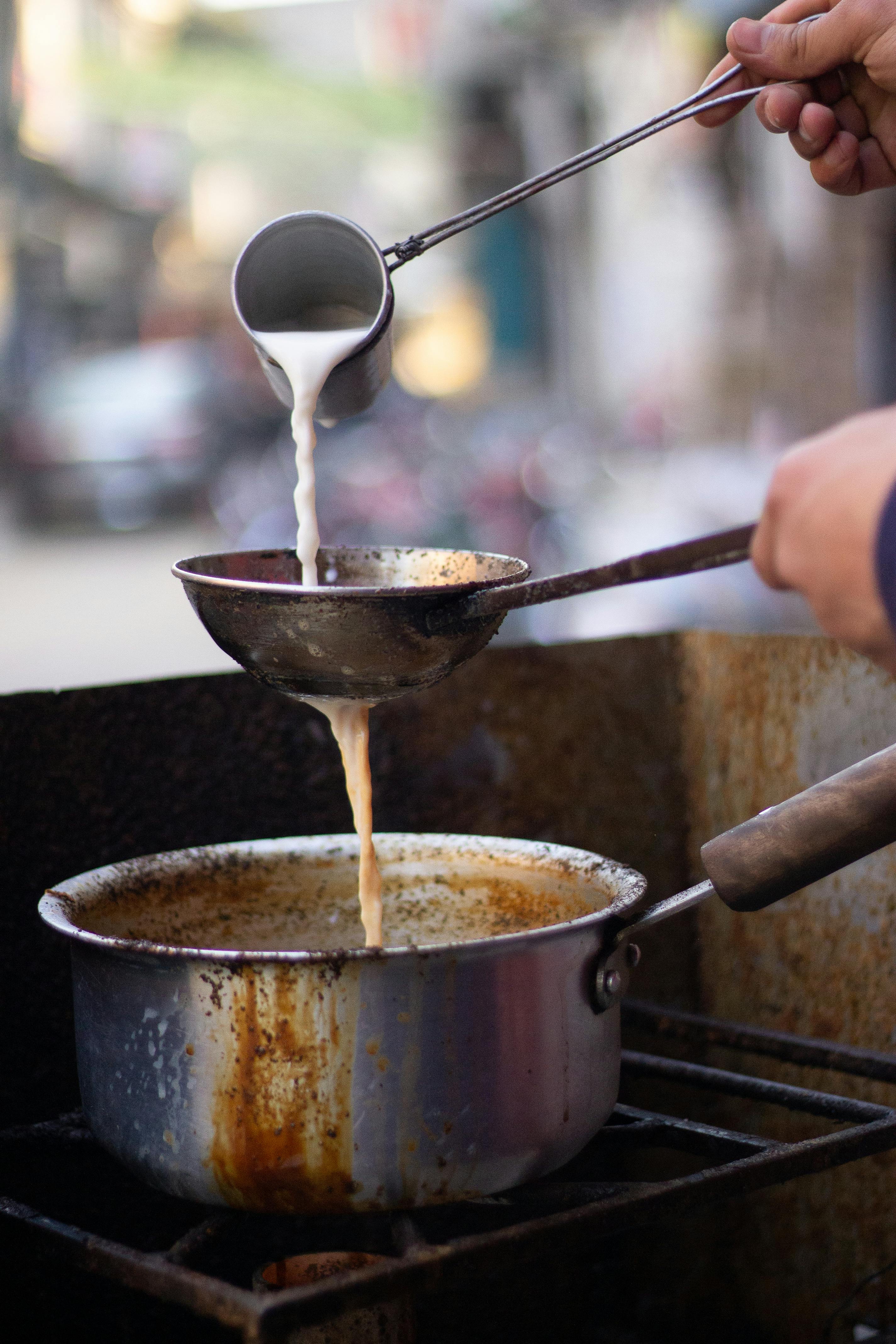 Hand Pouring Milk in Colander · Free Stock Photo