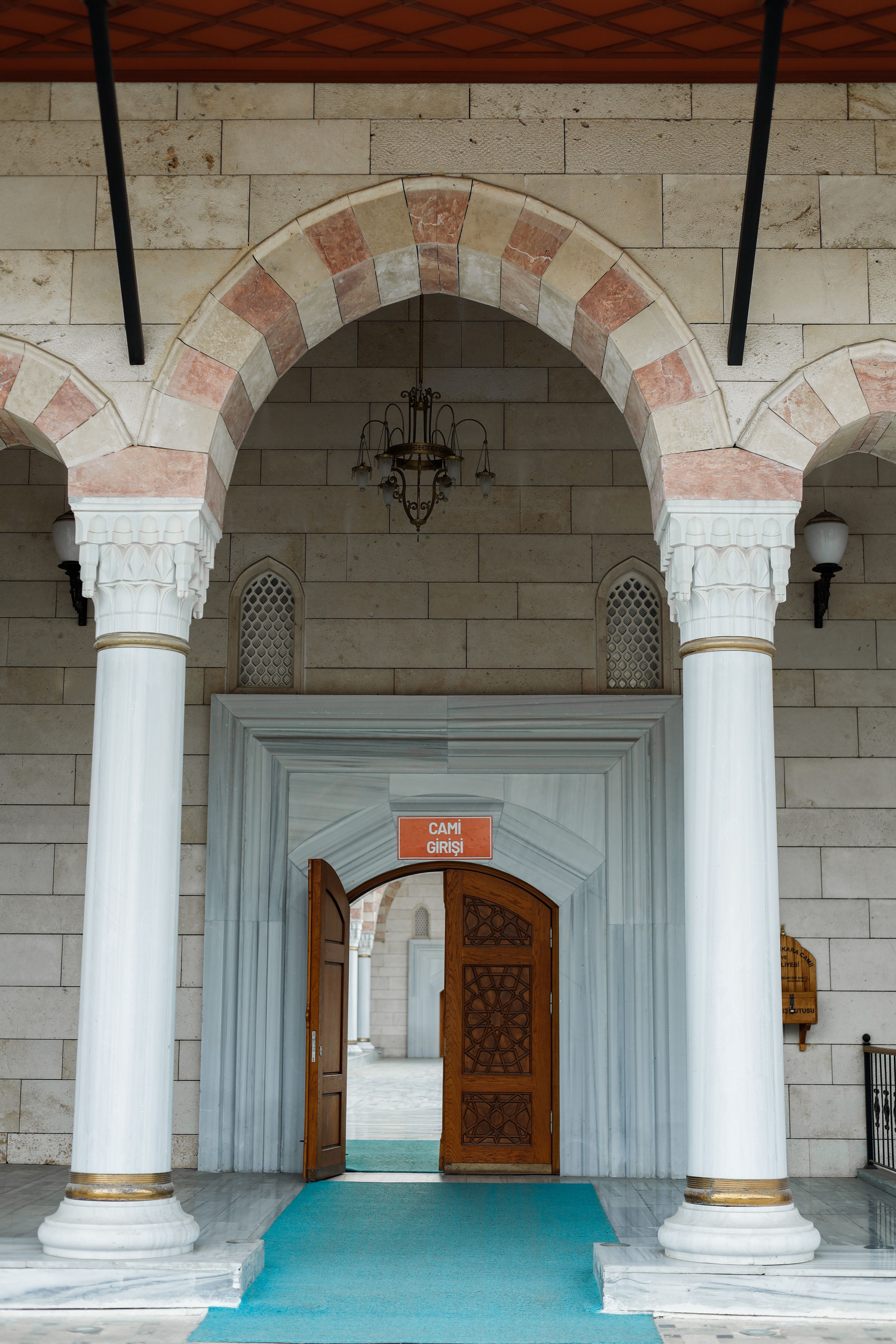 The entrance to a mosque with arches and columns · Free Stock Photo