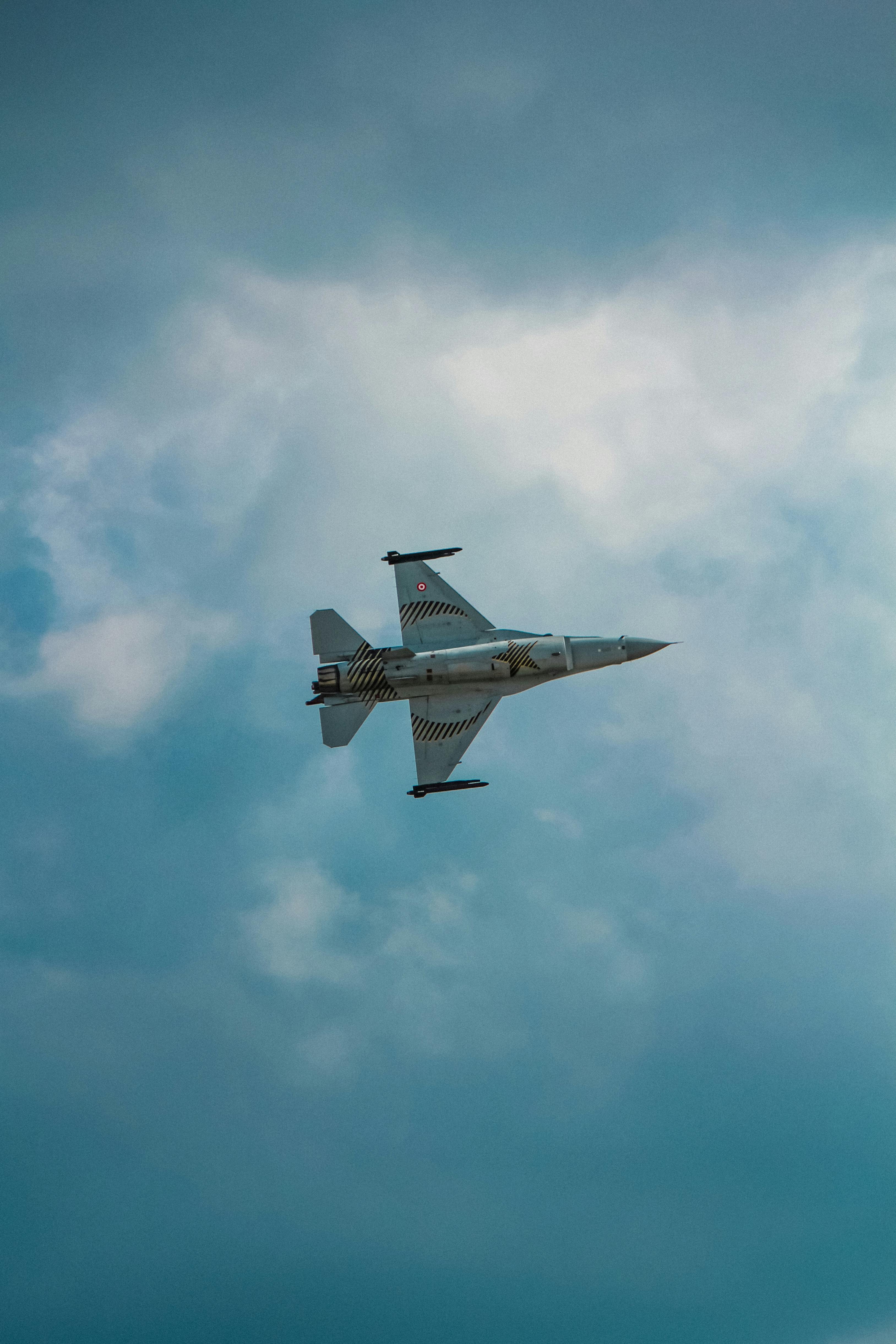 Grey Jet Plane Flying on Top of White Mountain · Free Stock Photo