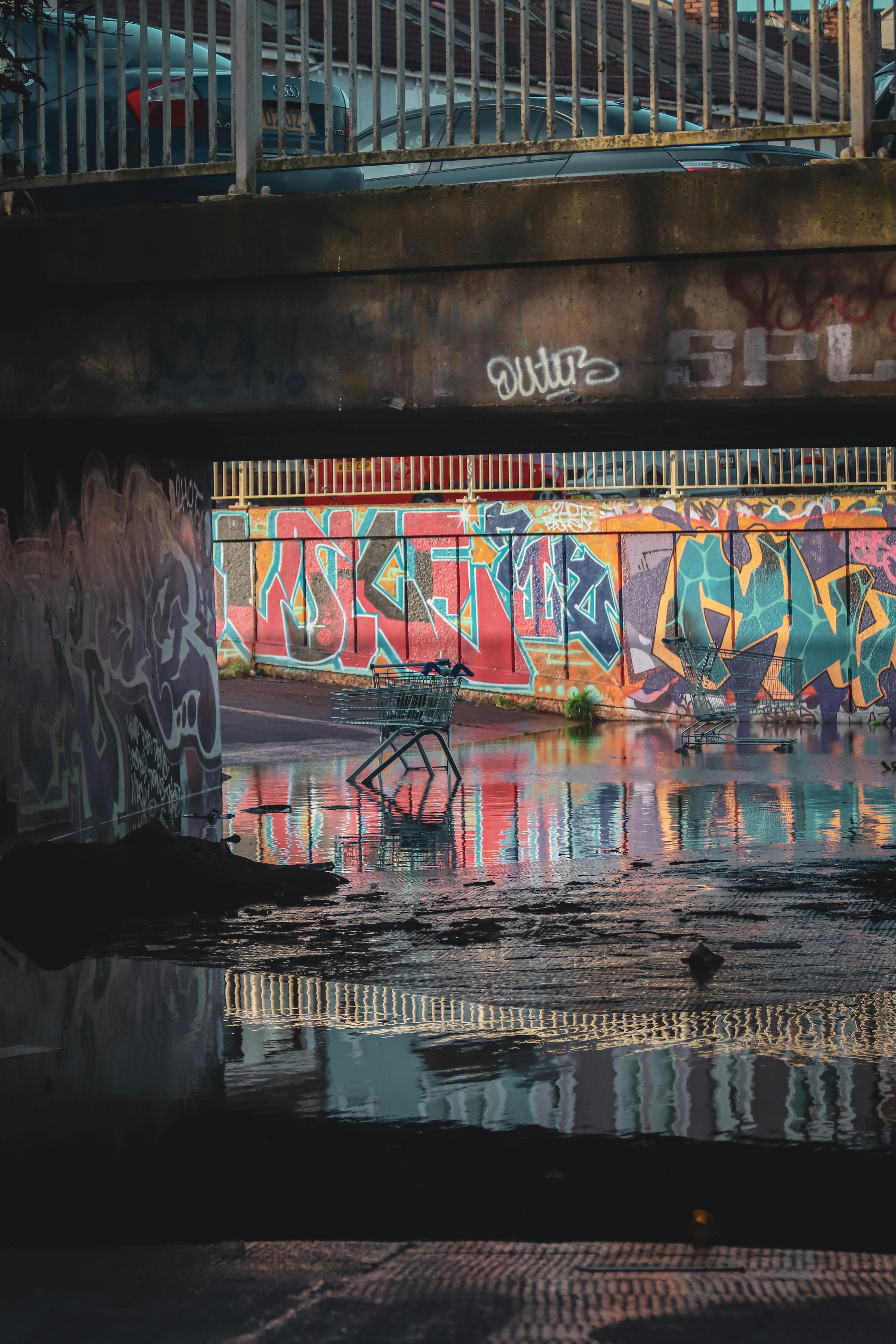 A bridge with graffiti on it and a reflection · Free Stock Photo