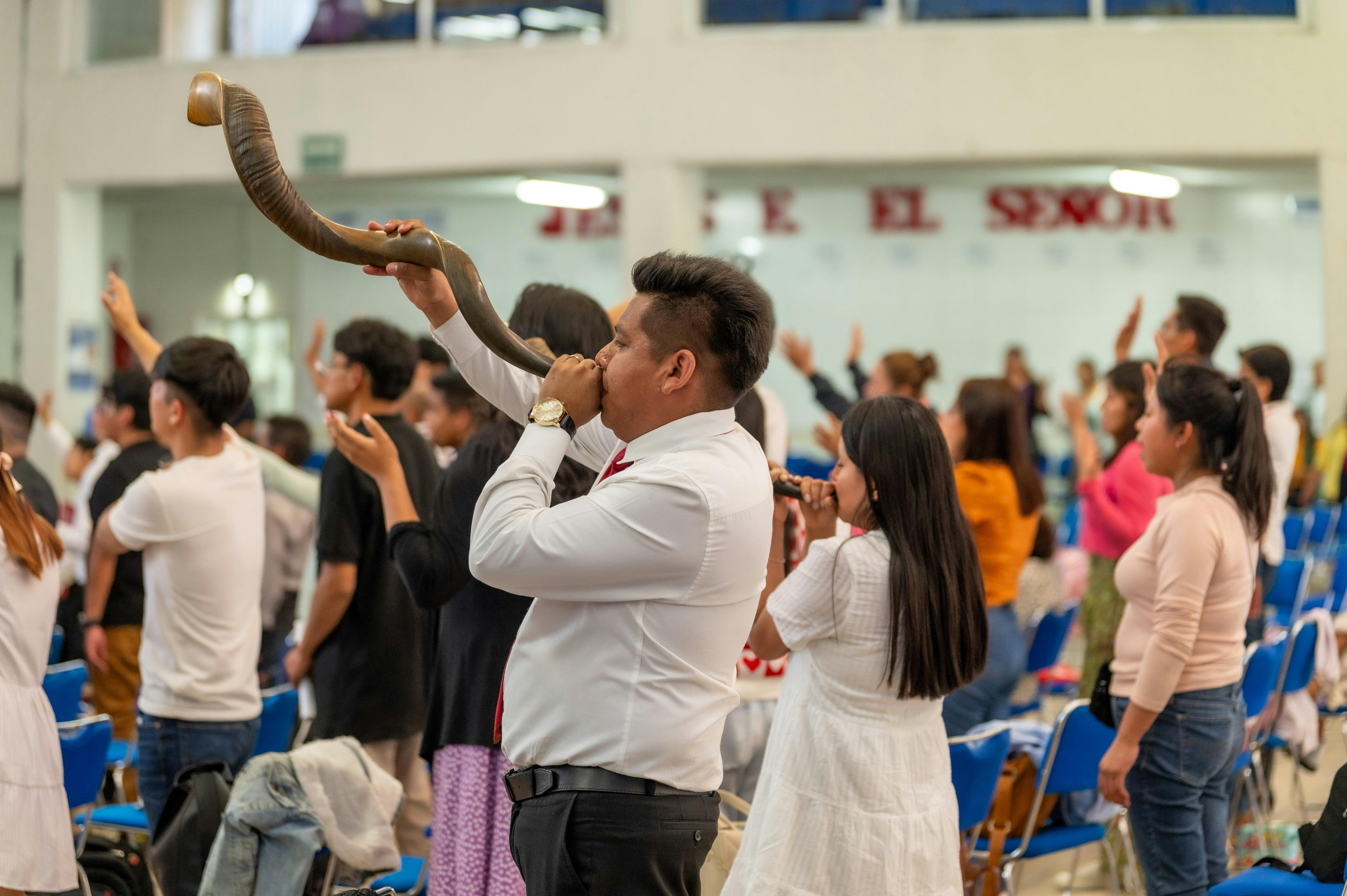 A man blowing a horn in a church · Free Stock Photo