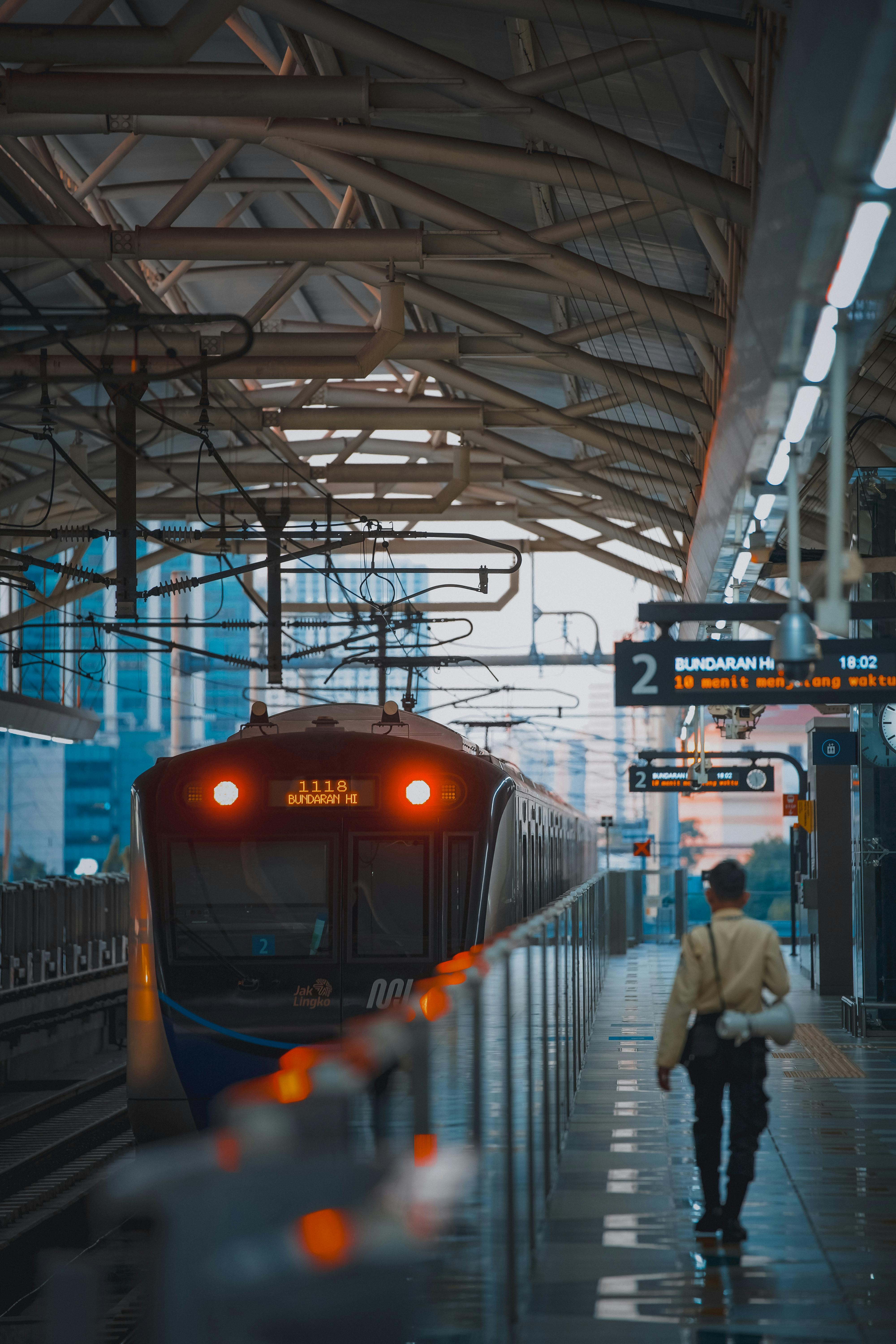 Man Walking on Platform at Railway Station · Free Stock Photo